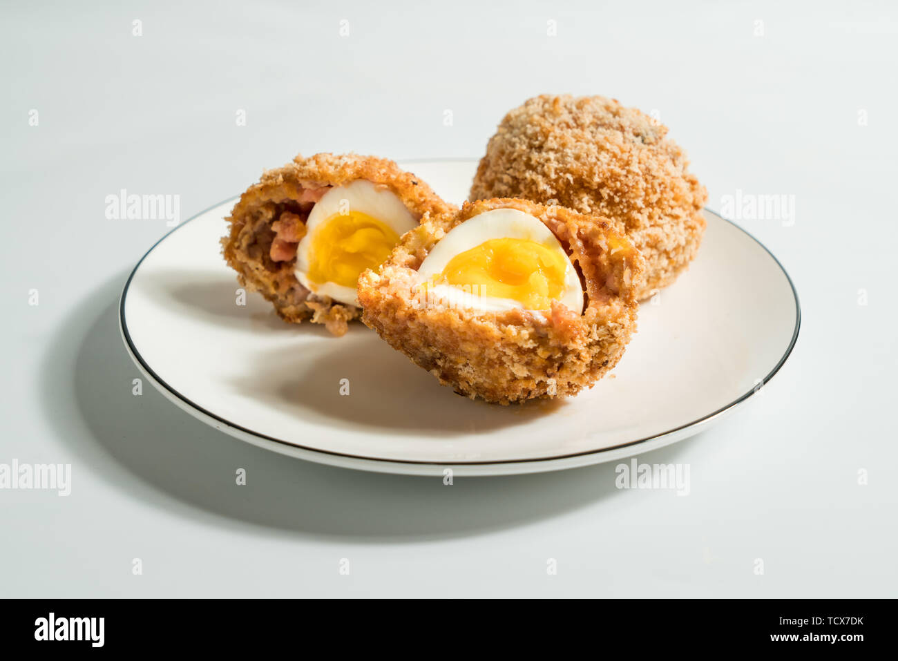 Scottish egg pendulum plate with white background Stock Photo - Alamy