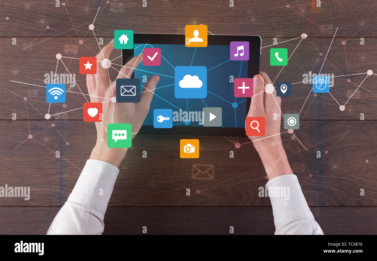 Hand touching multitask tablet with cloud wifi message social media ...