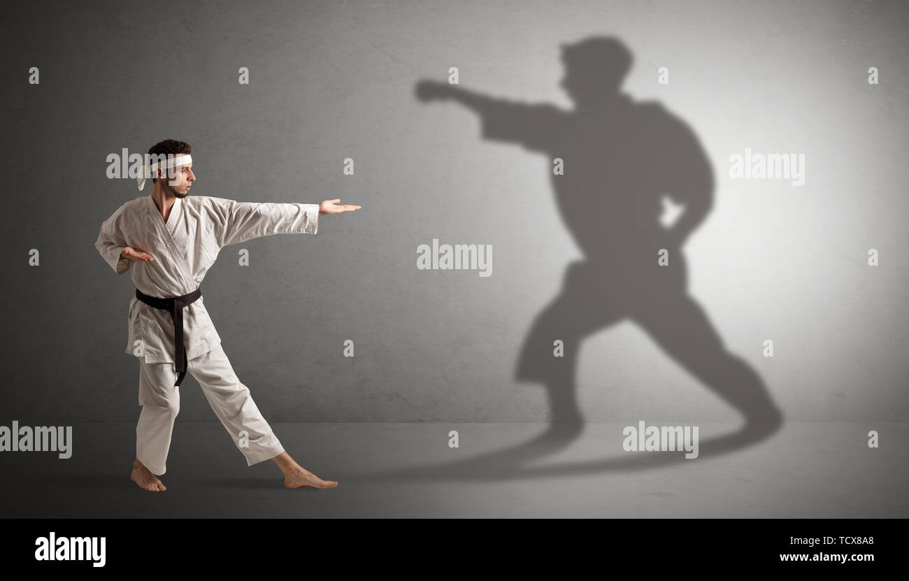 Young karate man confronting with his own shadow Stock Photo - Alamy