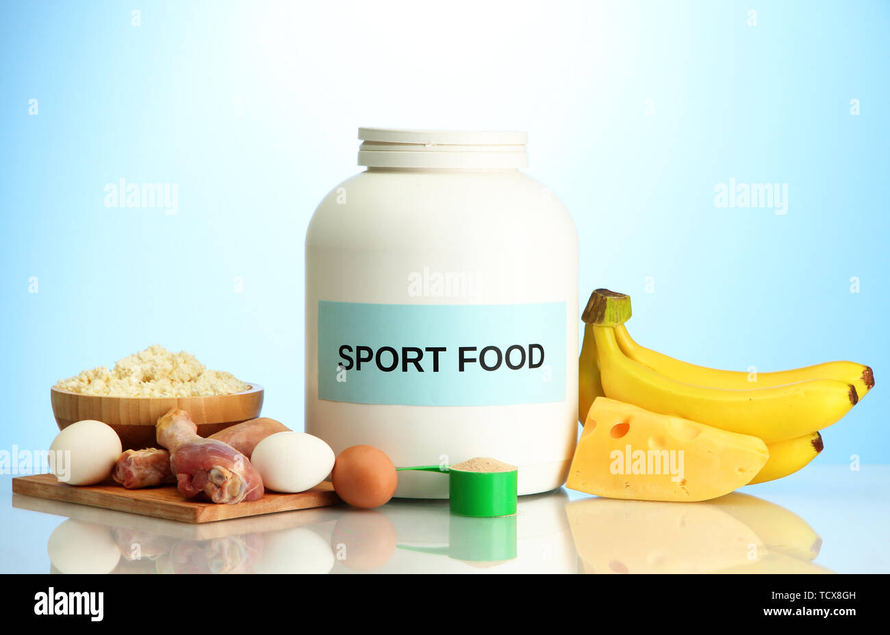jar of protein powder and food with protein, on blue background Stock ...