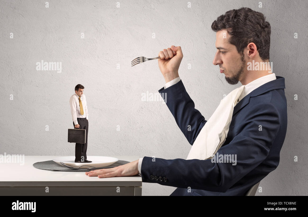 Tiny scared weak businessman almost devoured by great power Stock Photo ...