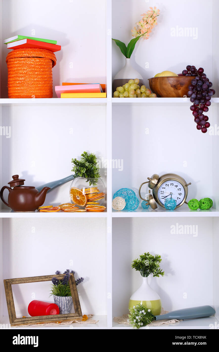 Beautiful white shelves with scattered different home related objects ...