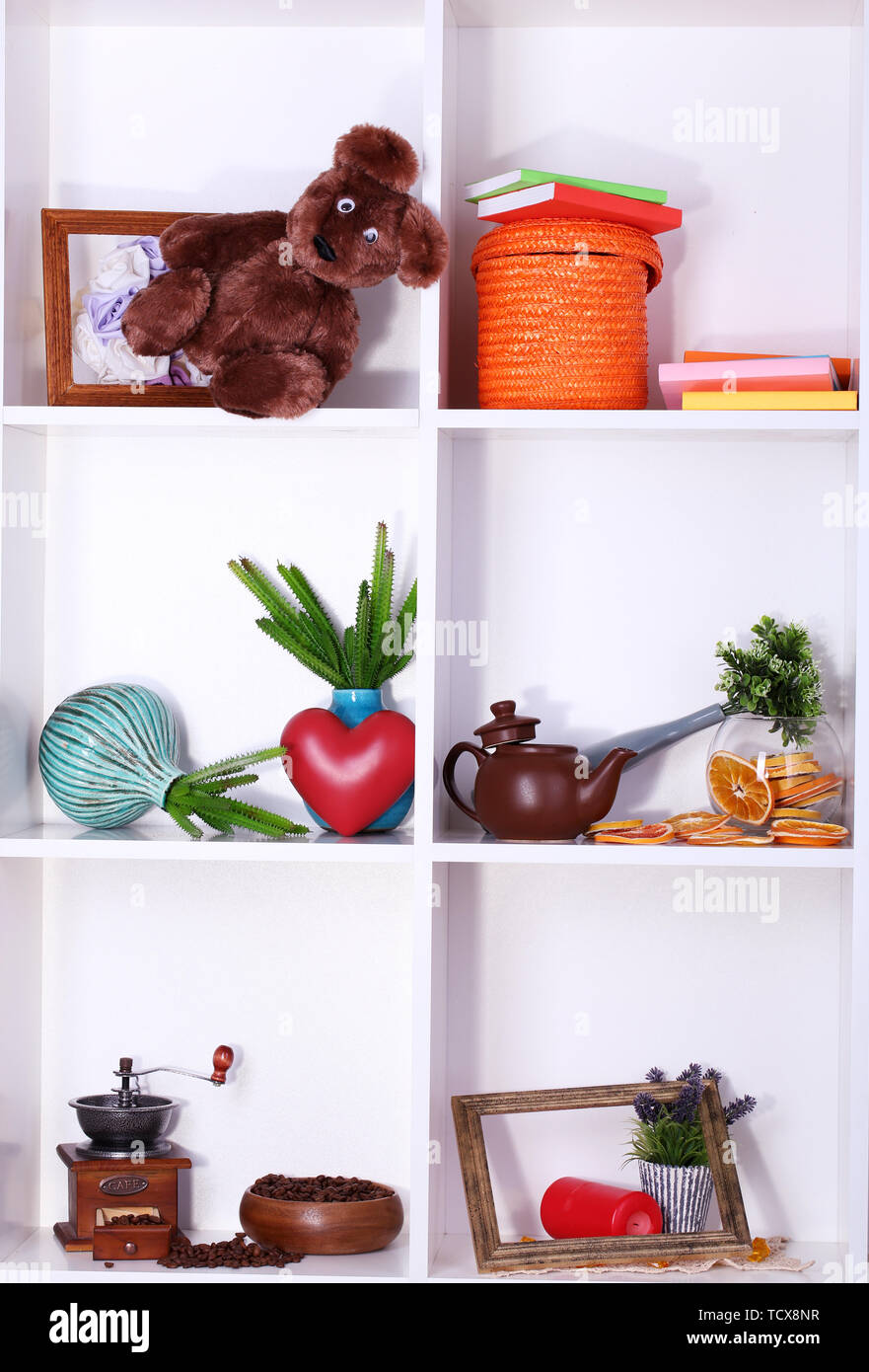 Beautiful white shelves with scattered different home related objects ...