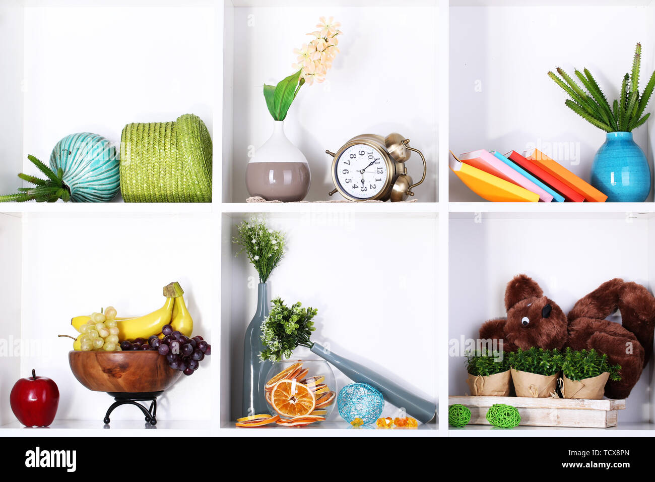 Beautiful white shelves with scattered different home related objects ...