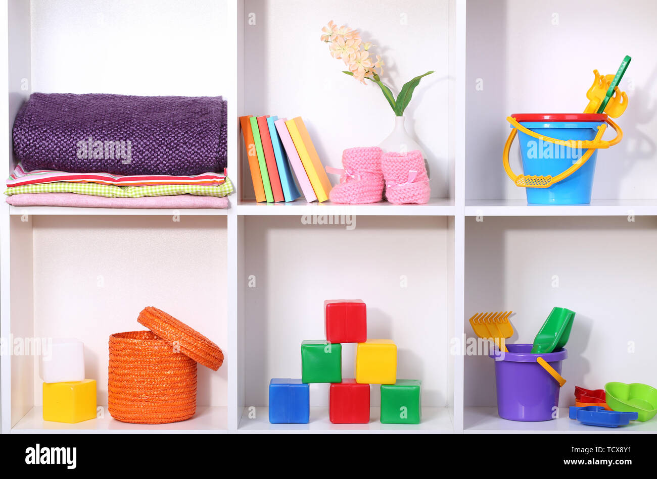 Beautiful white shelves with different baby related objects Stock Photo ...