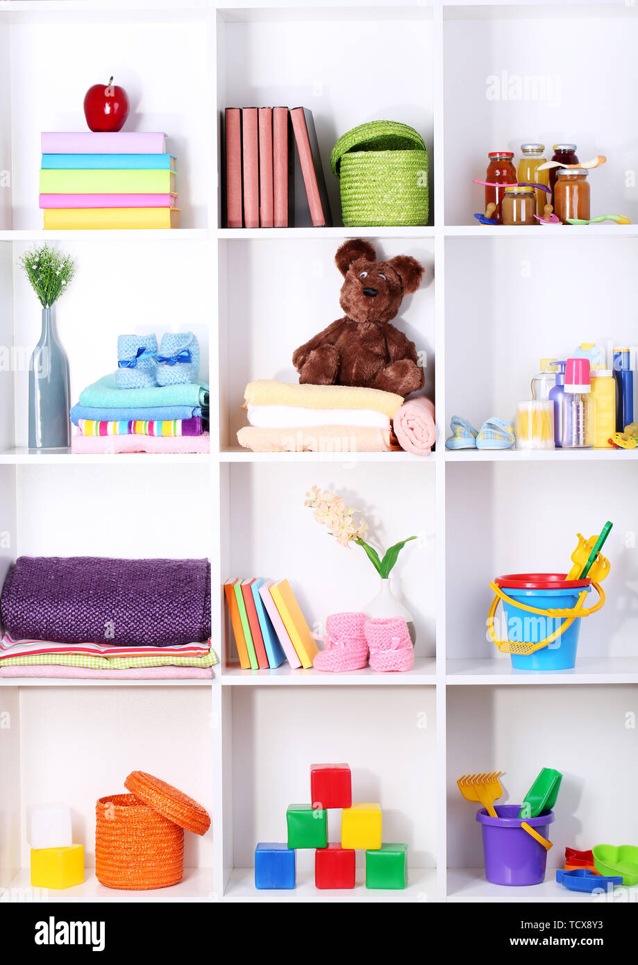 Beautiful white shelves with different baby related objects Stock Photo ...