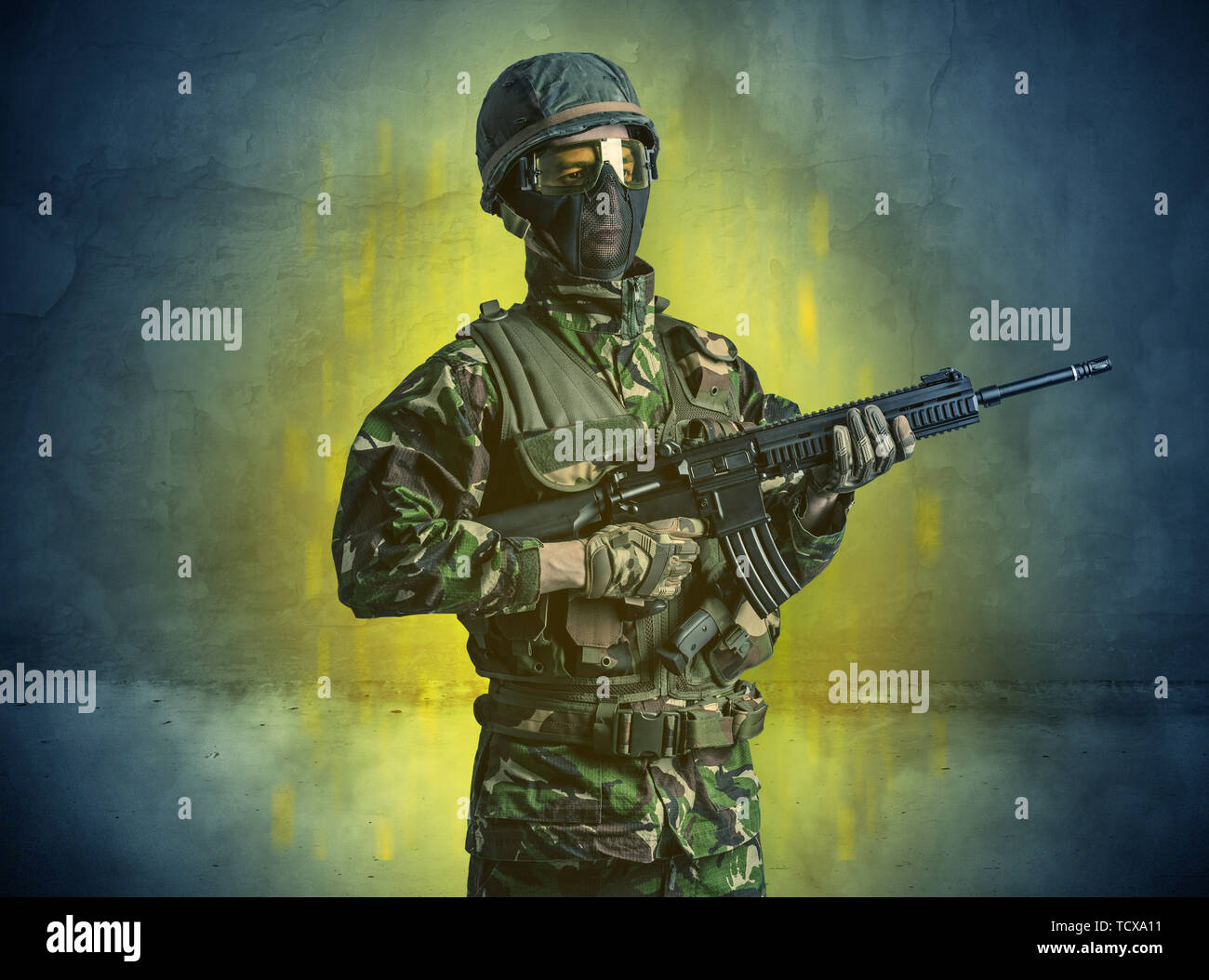 Hazard, menace soldier in a ruined crumbly building with arms on his ...