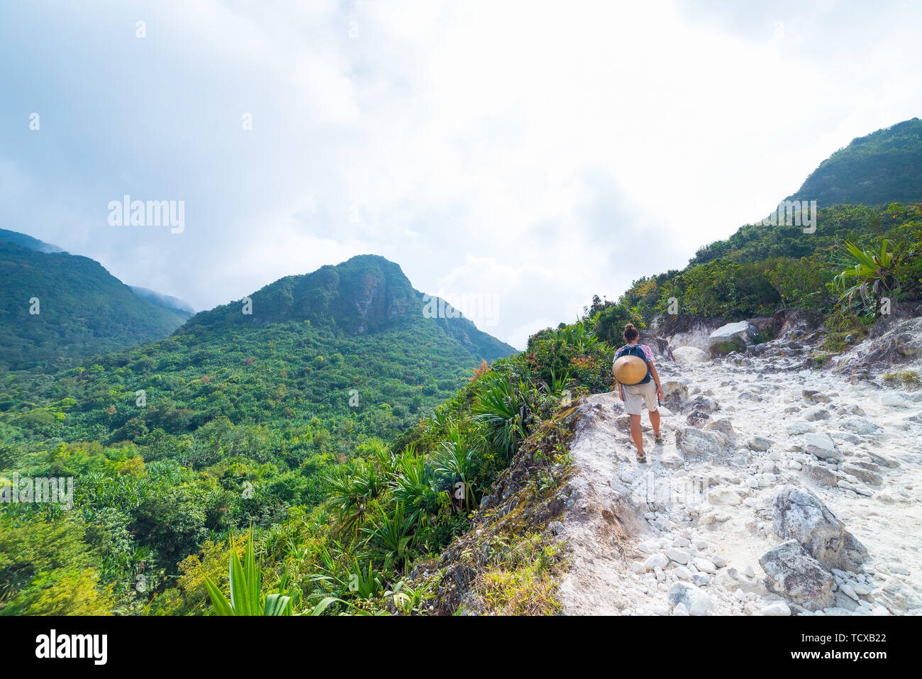 One tourist climbing Sibayak volcano, active caldera steaming, famous ...
