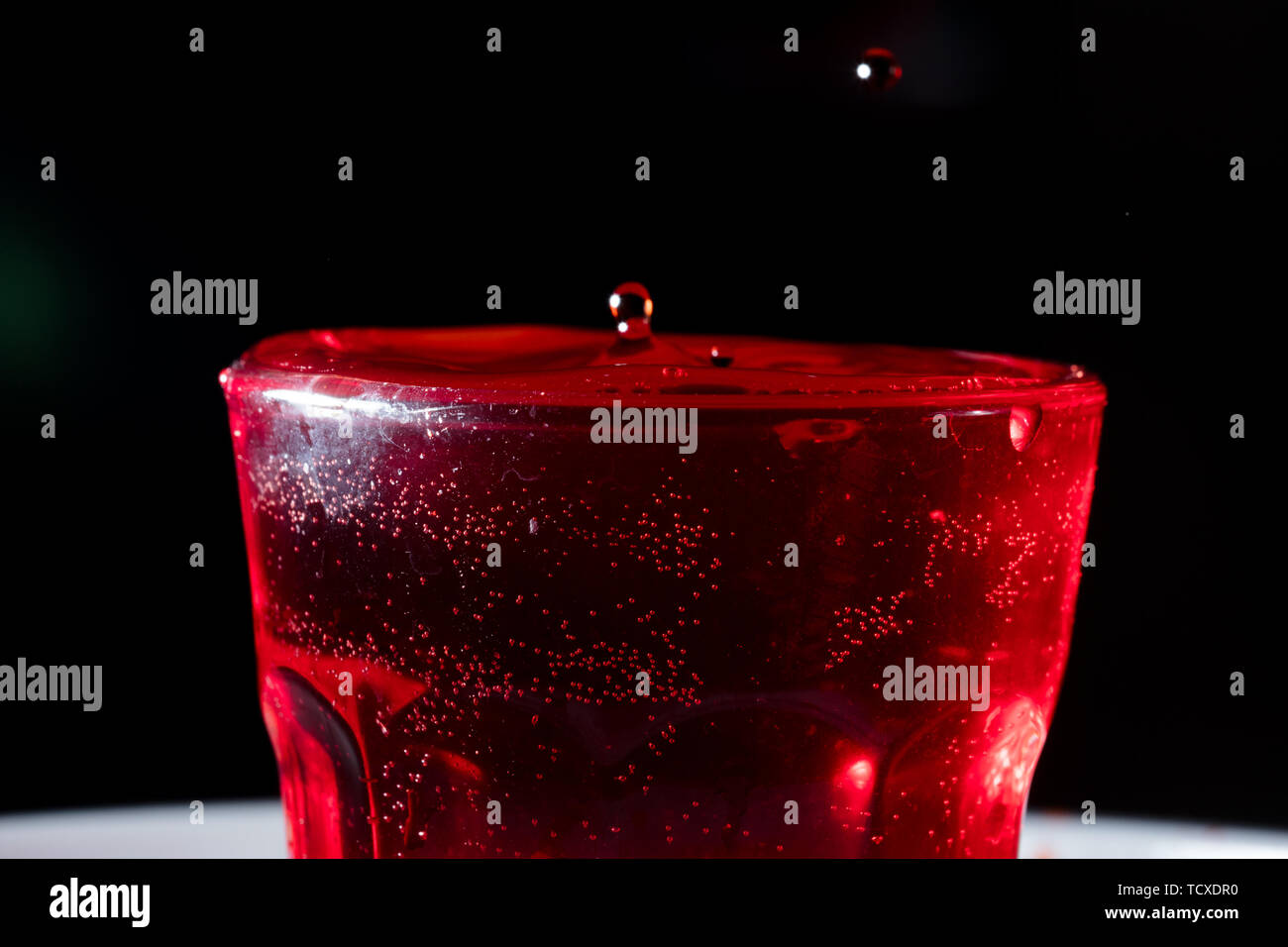drops of red liquid in glass beaker Stock Photo - Alamy