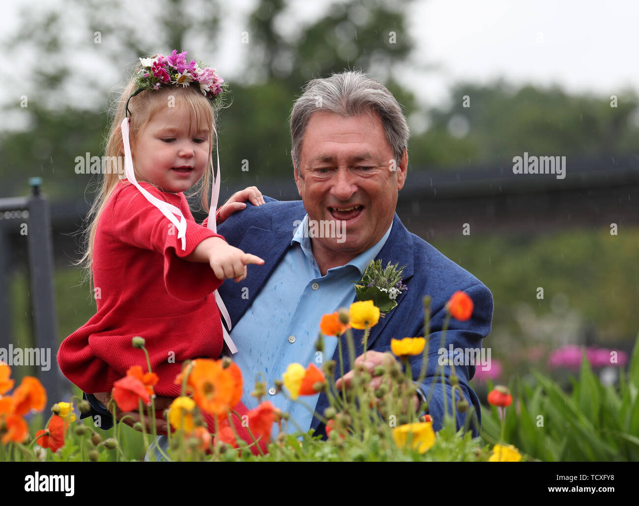 TV gardener Alan Titchmarsh holds 3-year-old Rosie O'Hare, before he ...