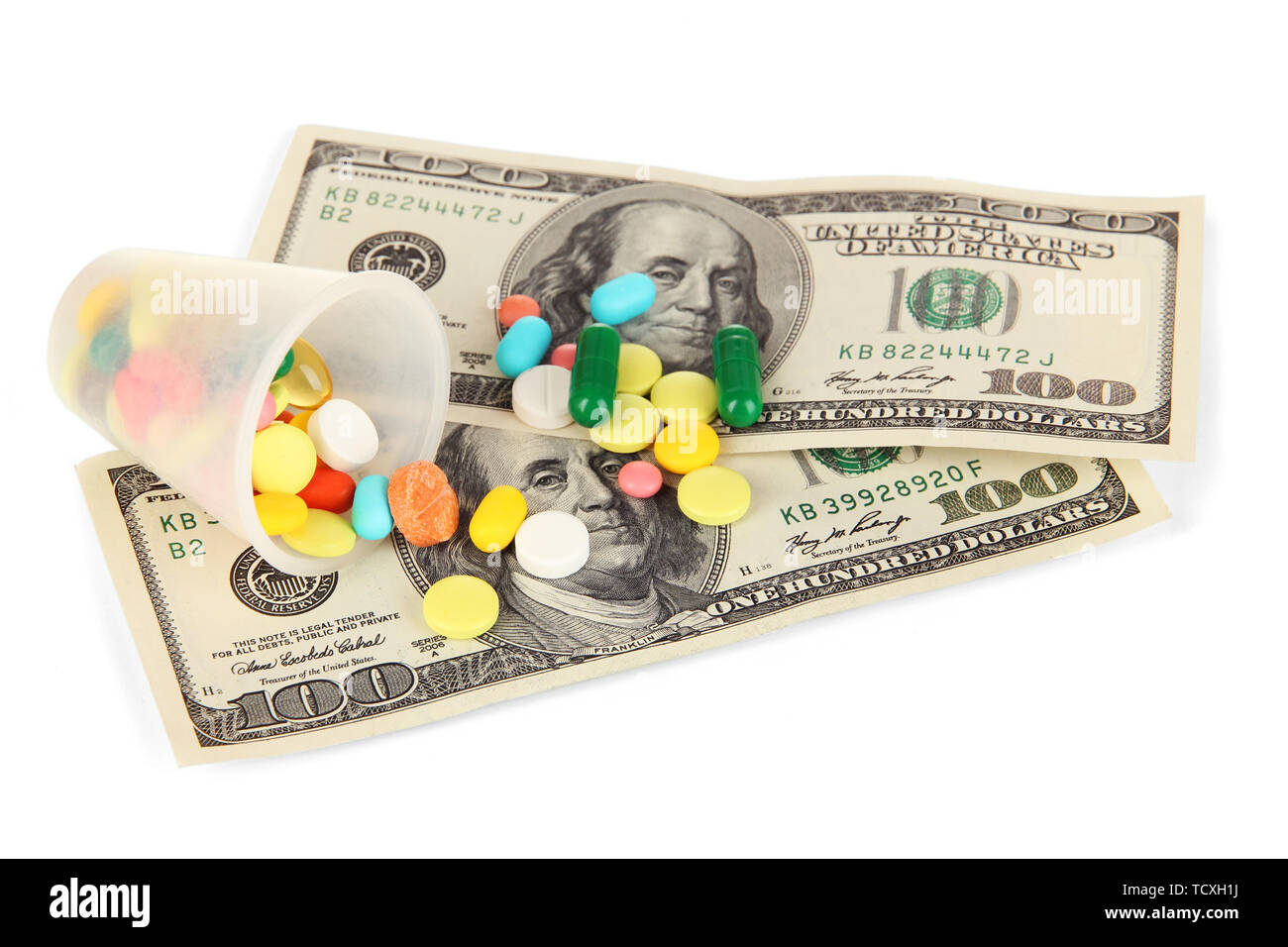 Pills and money isolated on white Stock Photo - Alamy