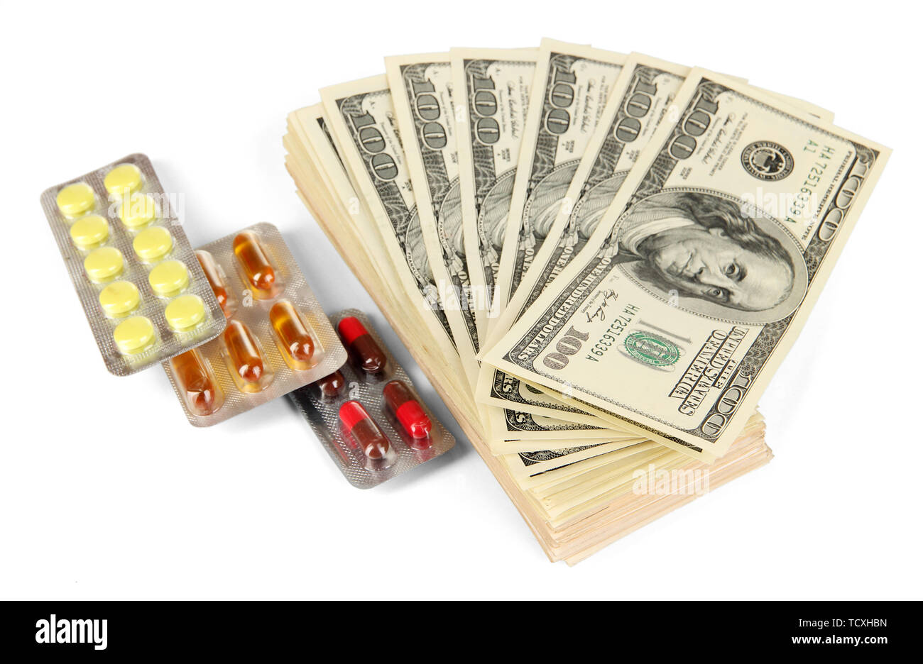 Pills and money isolated on white Stock Photo - Alamy
