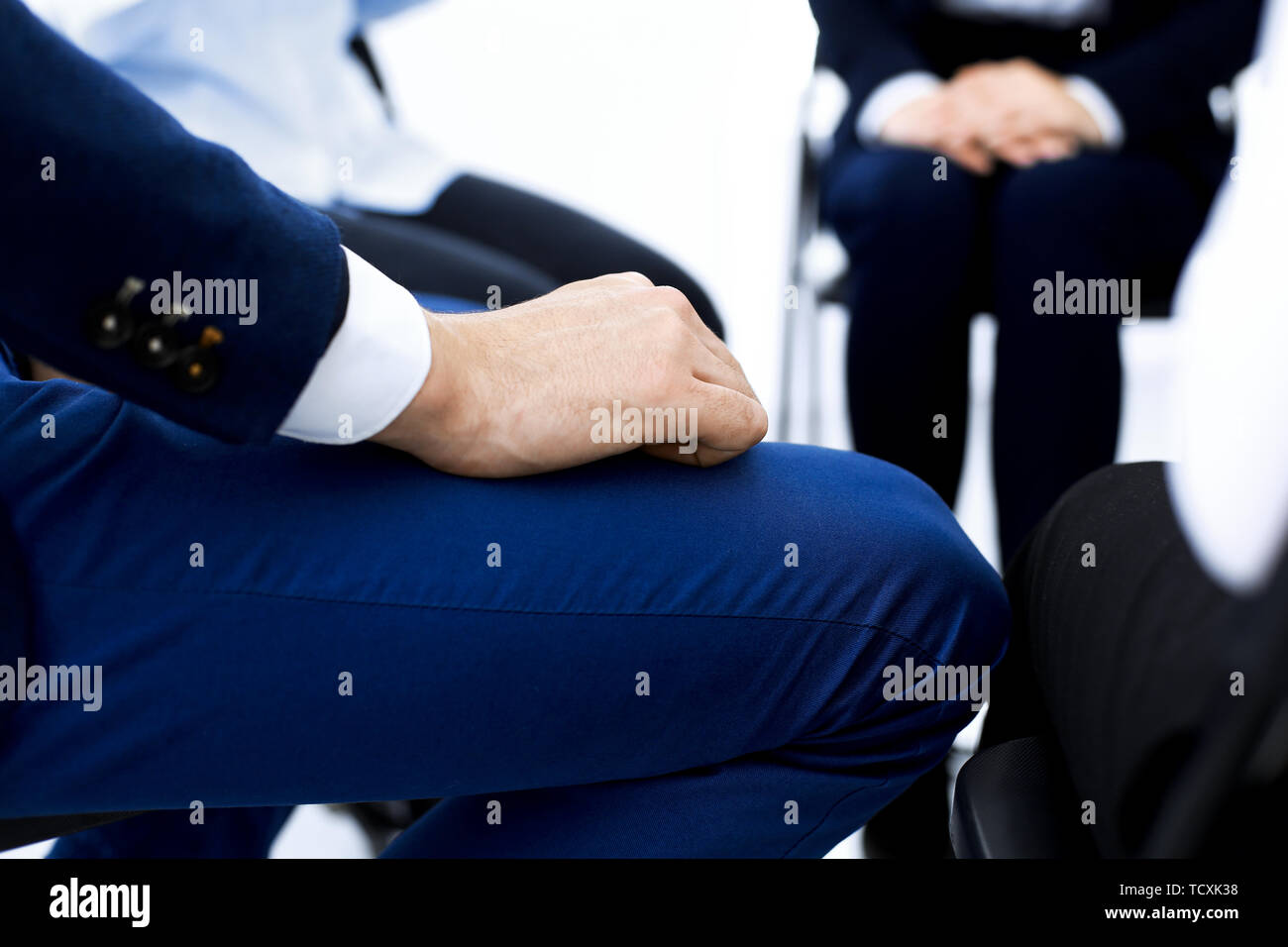 Group of people sitting in a circle during therapy. Meeting of business ...