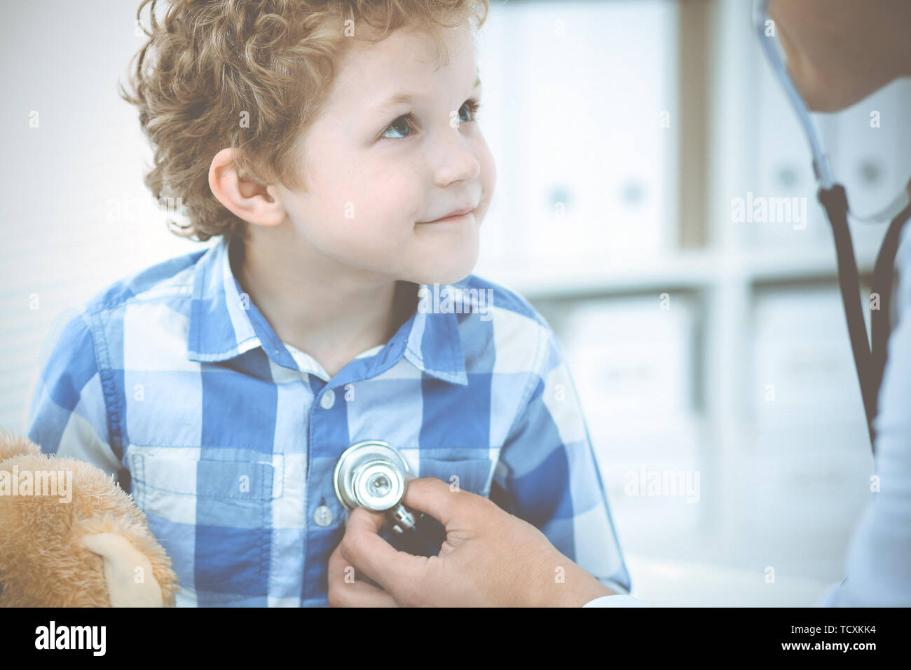 Doctor and patient child. Physician examining little boy. Regular ...