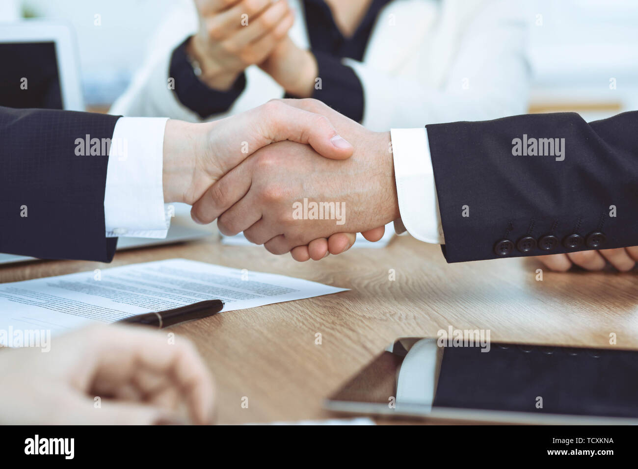 Business people shaking hands at meeting or negotiation in the office ...