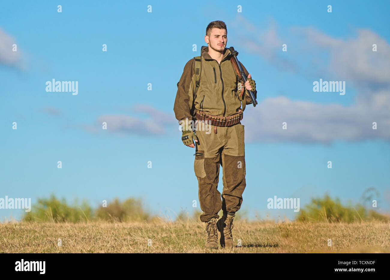 Masculine hobby activity. Man hunter carry rifle blue sky background ...