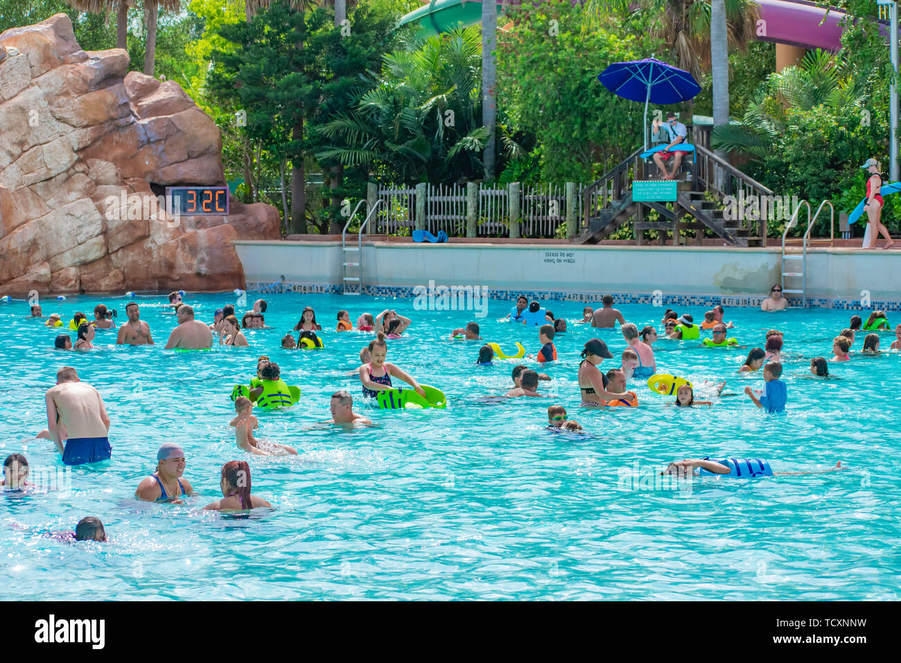 Orlando, Florida. April 07, 2019. Parent and kids enjoying pool with ...