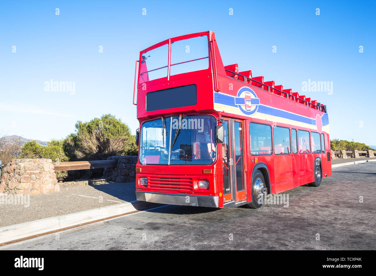 red sightseeing bus on rural road in blue sky Stock Photo - Alamy