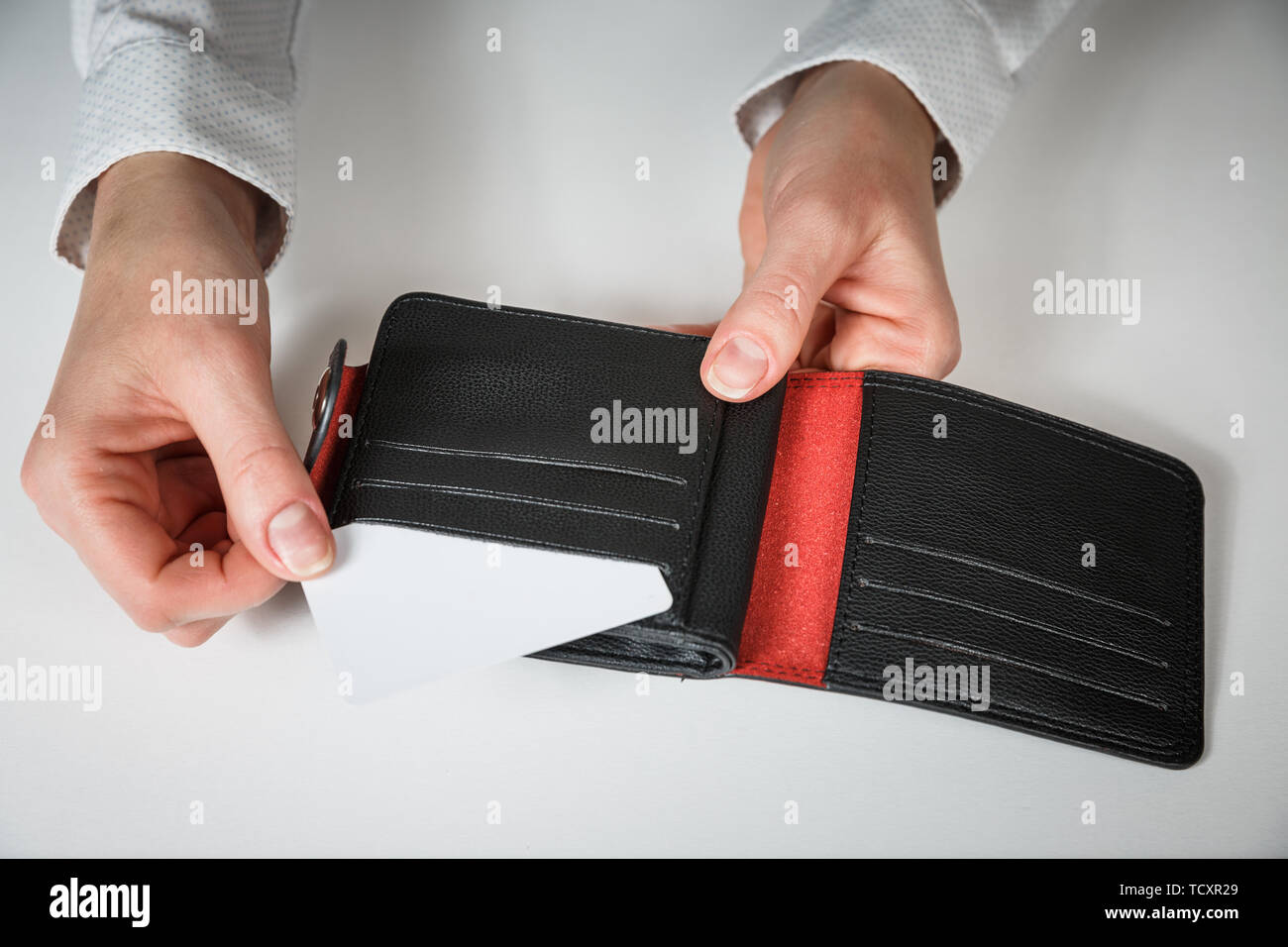 Woman hand hold and bring out card in her purse with white background ...