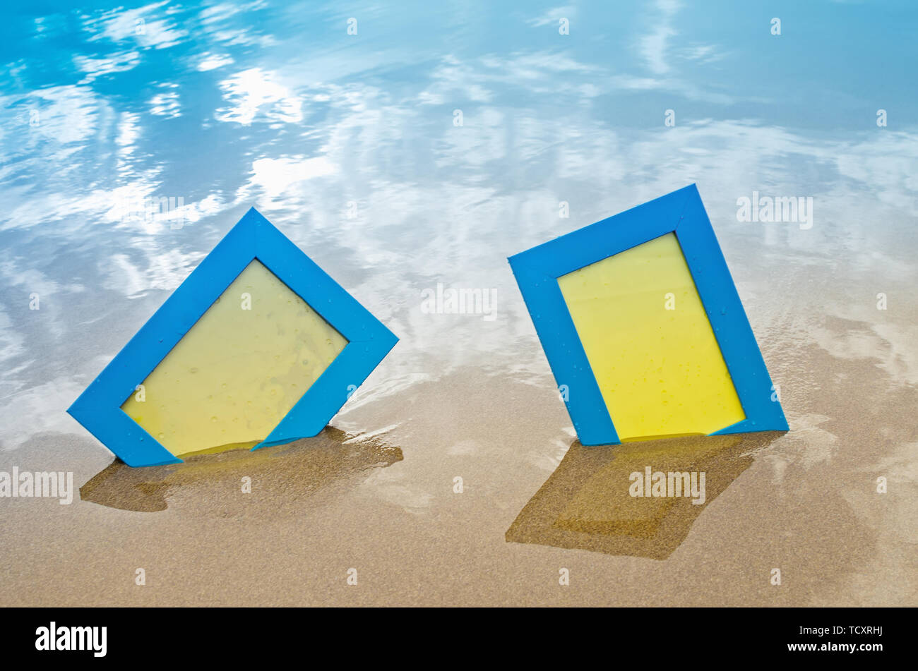 Two blue blank photo frames on the sand beach Stock Photo - Alamy
