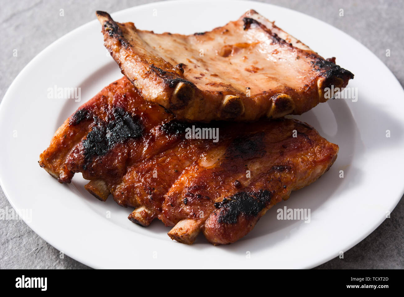 Grilled barbecue ribs on gray stone background Stock Photo - Alamy