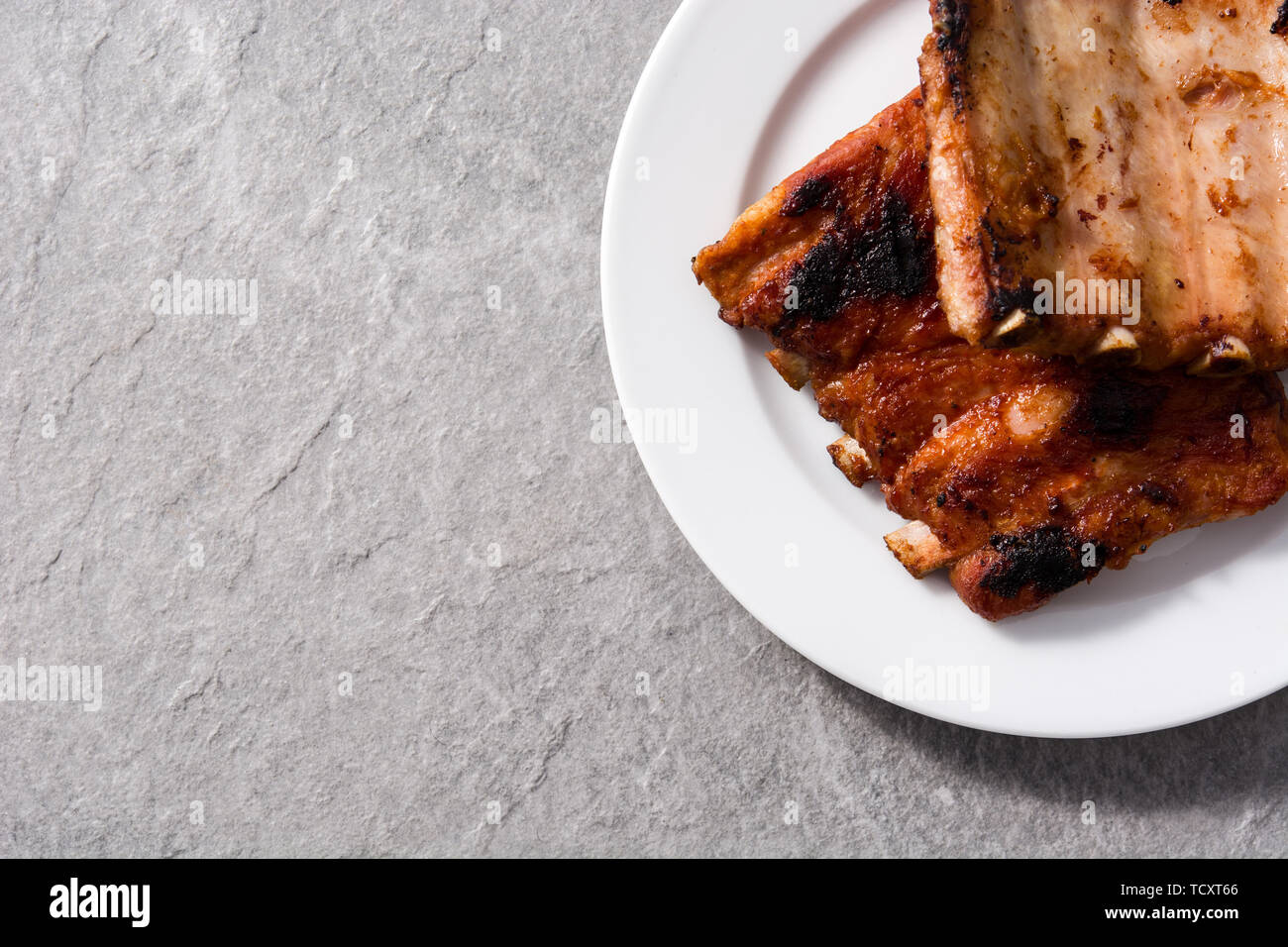 Grilled barbecue ribs on gray stone background Stock Photo - Alamy