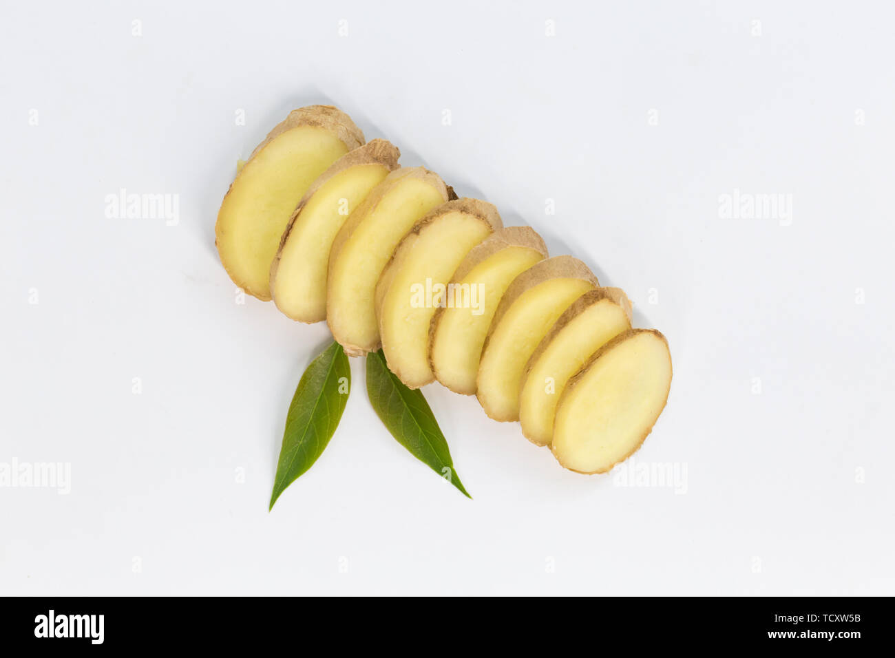 Ginger and cut ginger slices on white background Stock Photo - Alamy