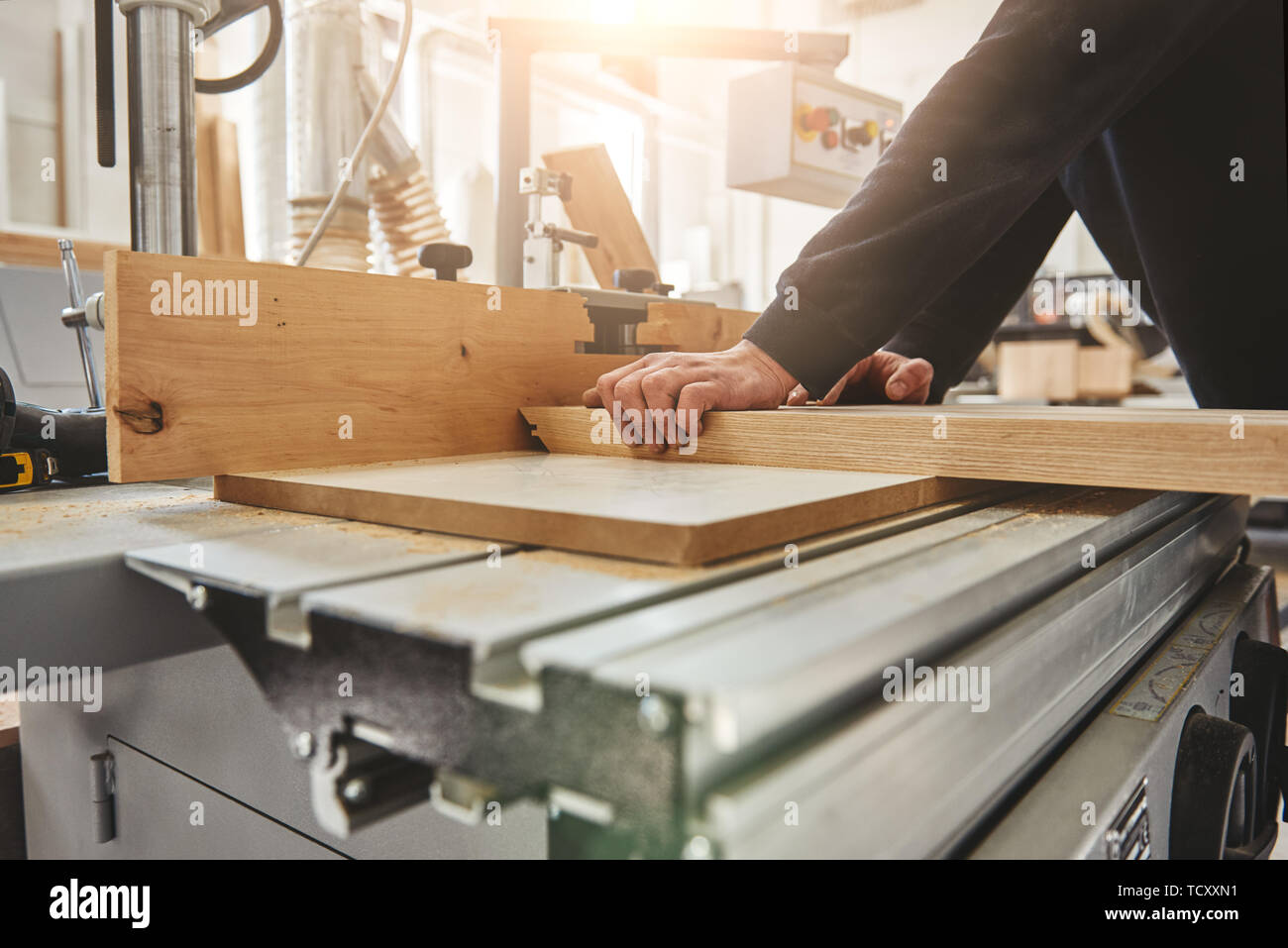 Close up of circular saw for cutting boards and the hands of the ...