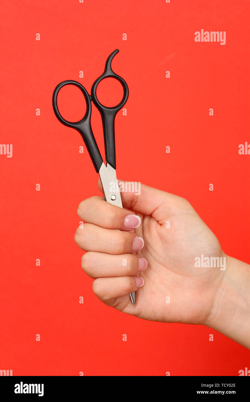 Female hand with scissors isolated on white Stock Photo - Alamy