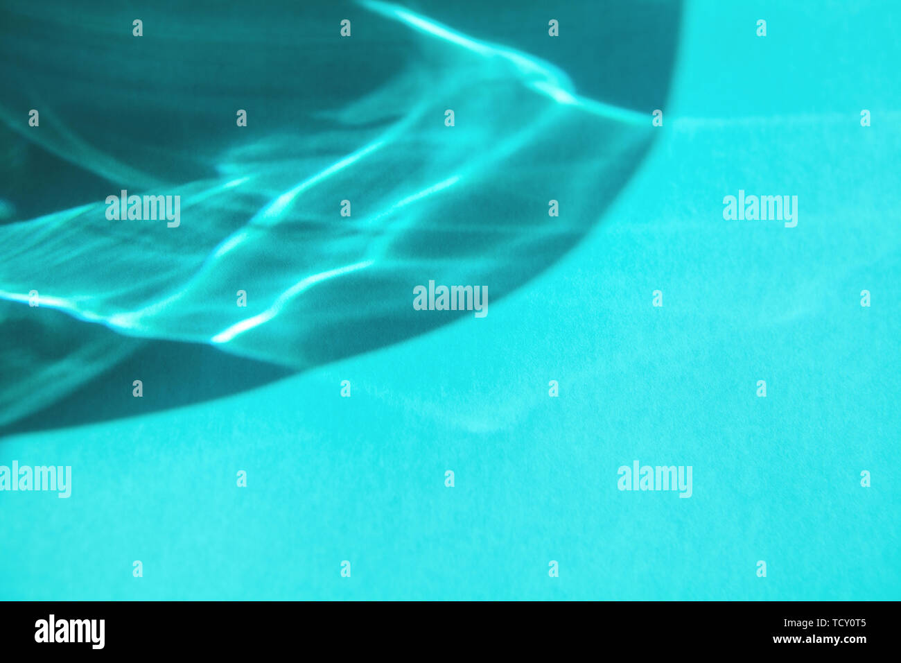 Trendy blue colored abstract background with light and shadows caustic ...