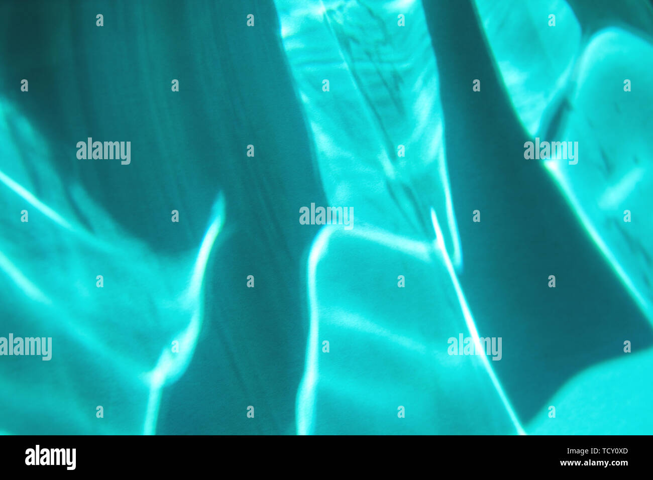 Trendy blue colored abstract background with light and shadows caustic ...