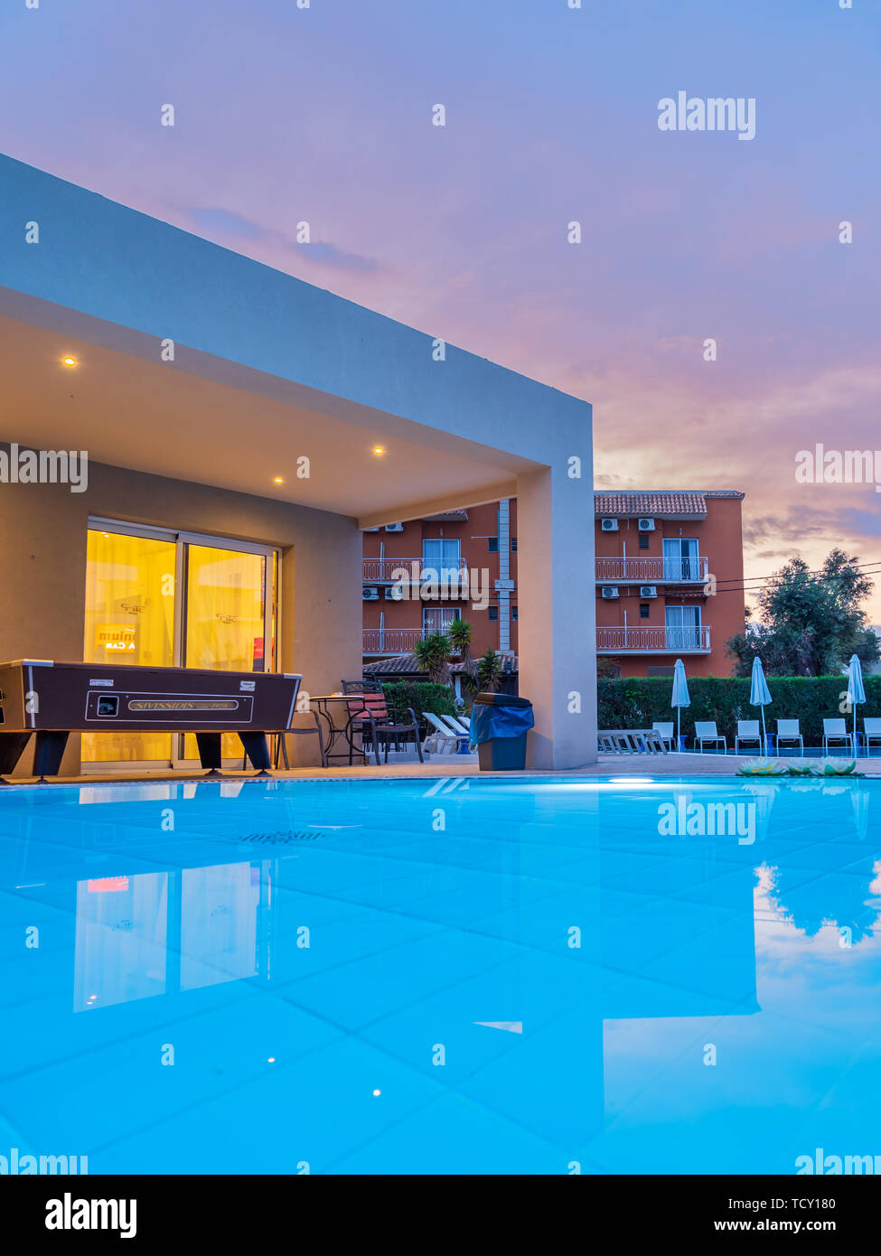 Swimming pool at the summer holydays resort hotel at sunset Stock Photo ...