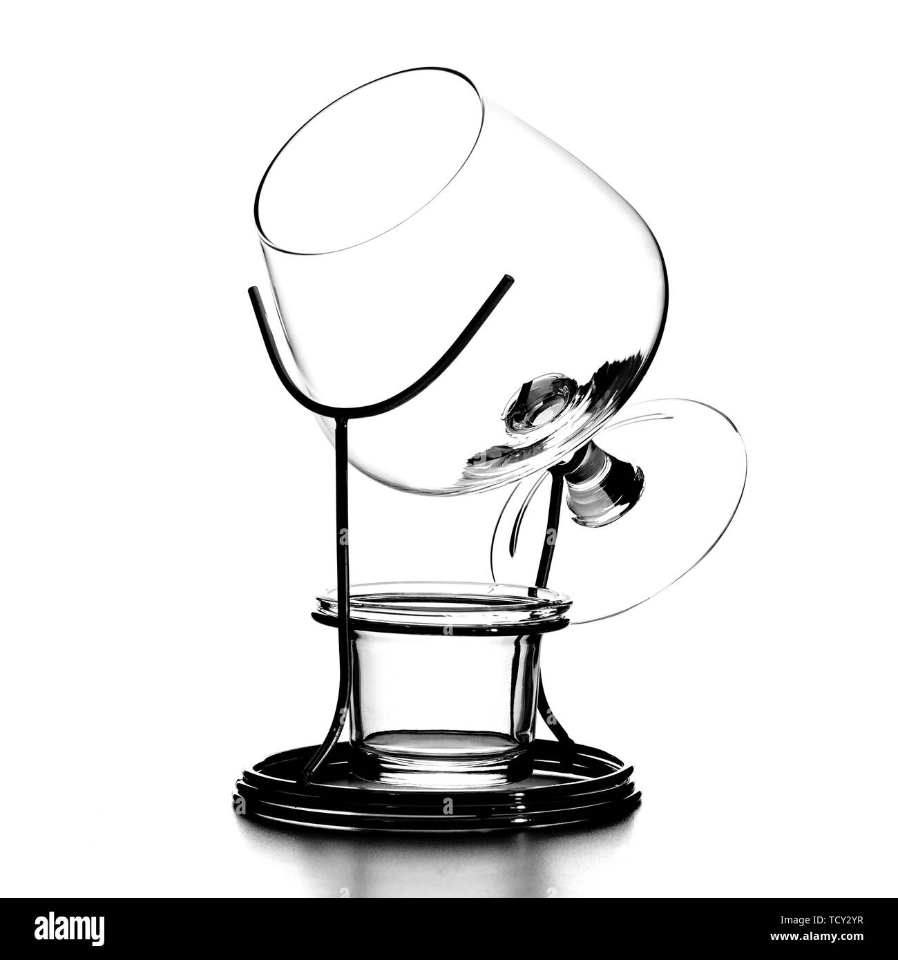 Isolated objects: a small single empty classic cognac glass, on a metal ...