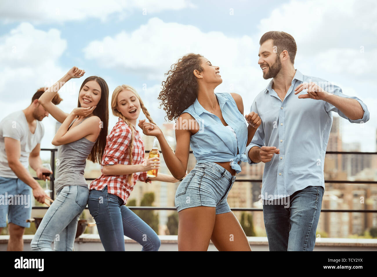 Let's dance! Group of happy and playful young people are are dancing ...