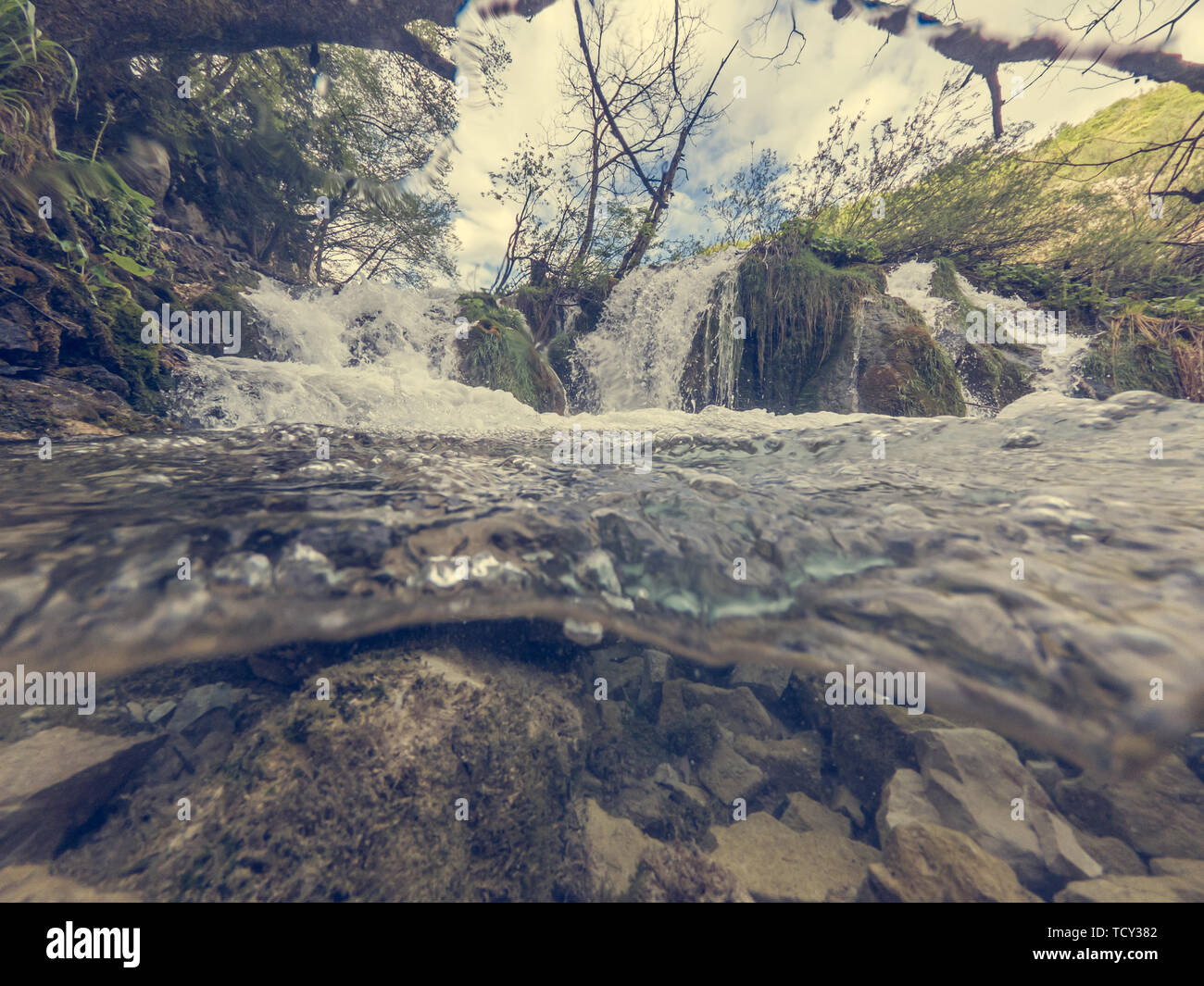Amazing split view of waterfalls falling into lake Stock Photo - Alamy