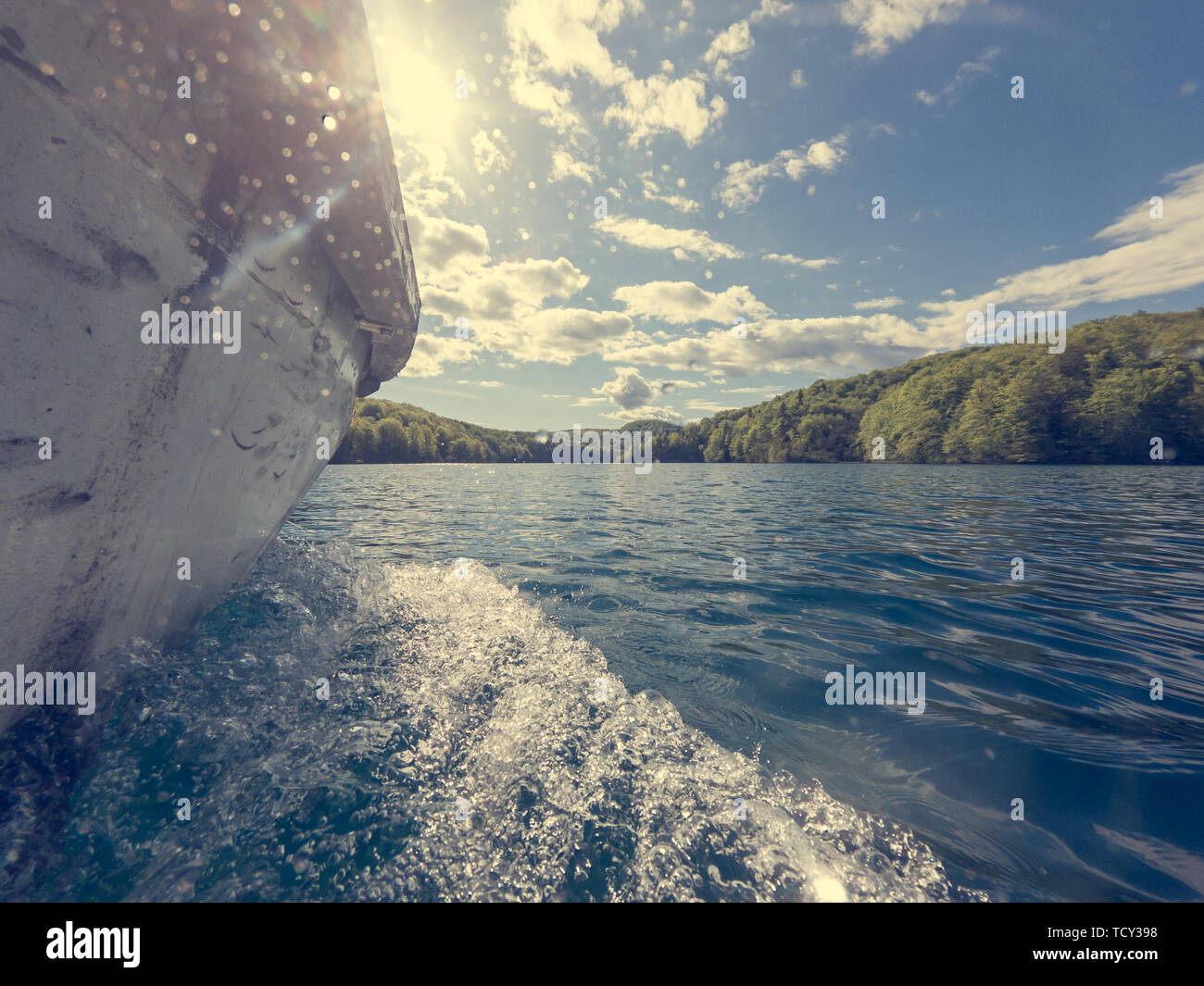 Side view of boat cruising along lake from just above the water Stock ...