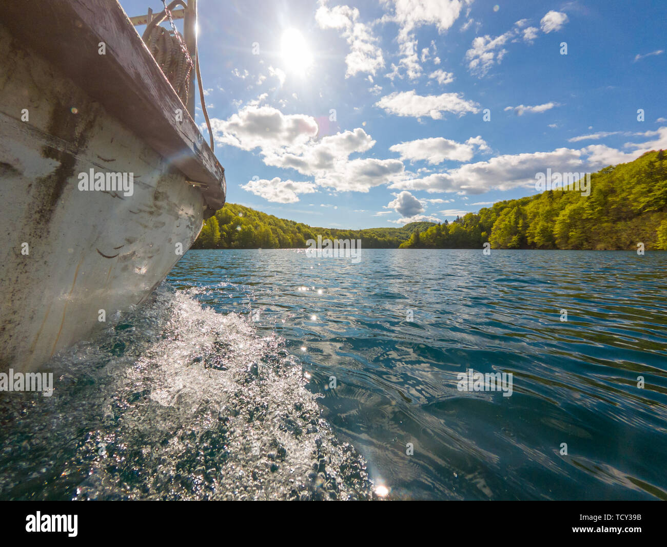 Side view of boat cruising along lake from just above the water Stock ...