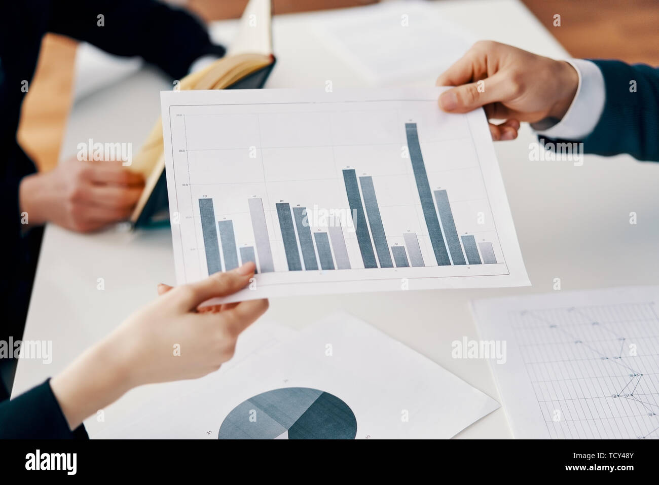 Business people showing business and financial report with increasing ...