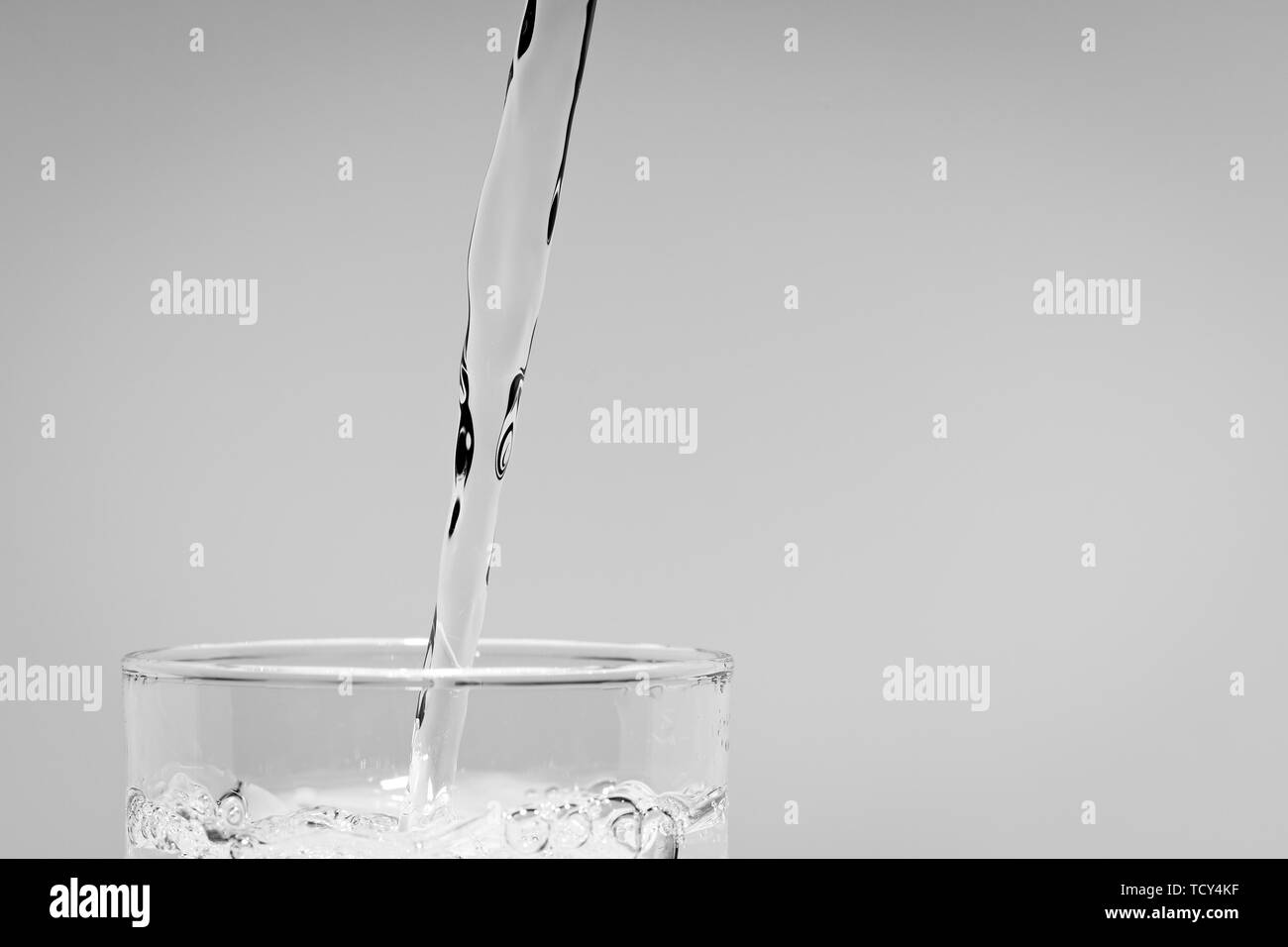 Pouring Water Into Glass Black and White Stock Photos & Images - Alamy