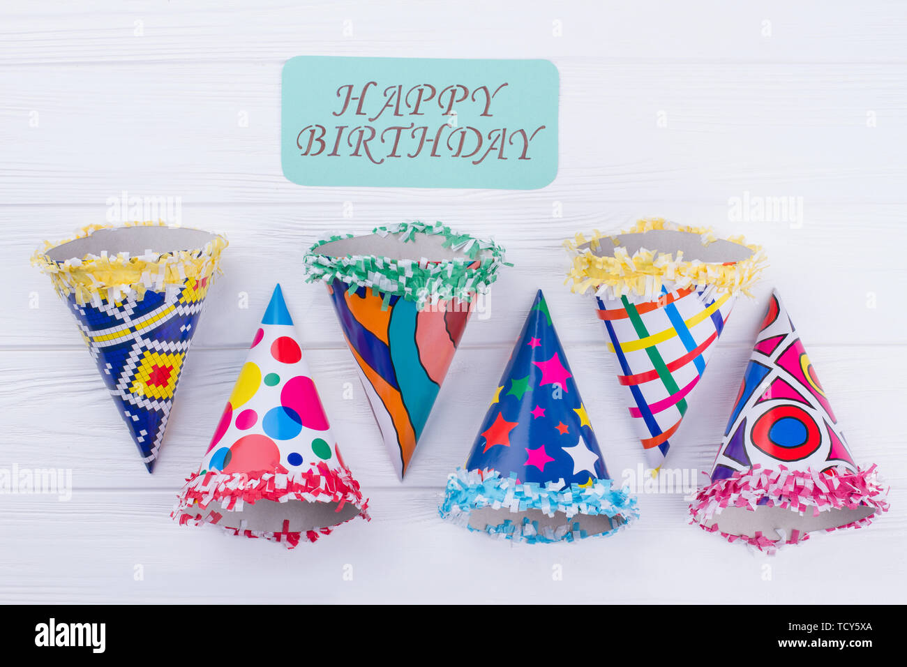 Happy Birthday composition with party hats Stock Photo - Alamy