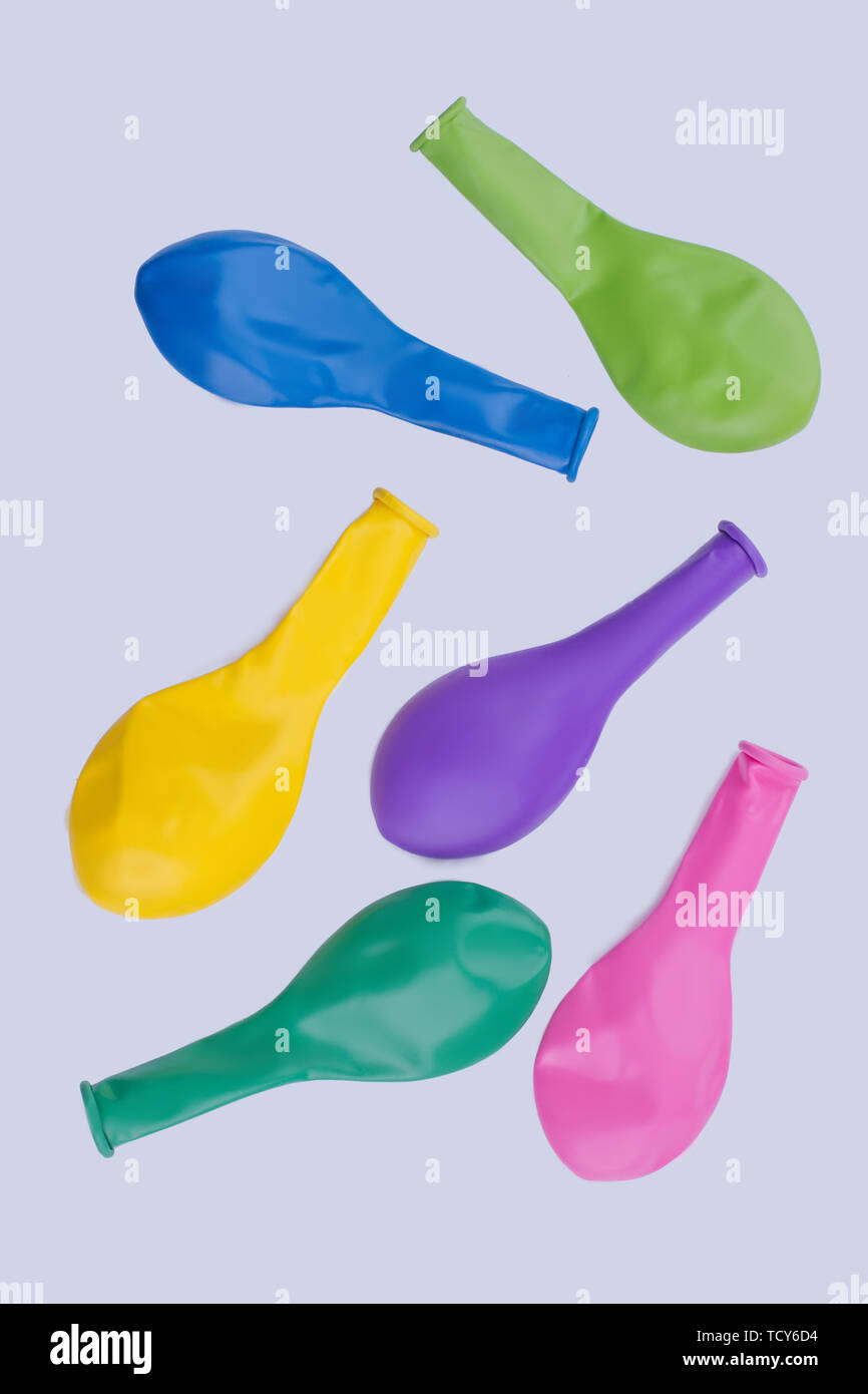 Colorful deflated balloons on white background Stock Photo - Alamy