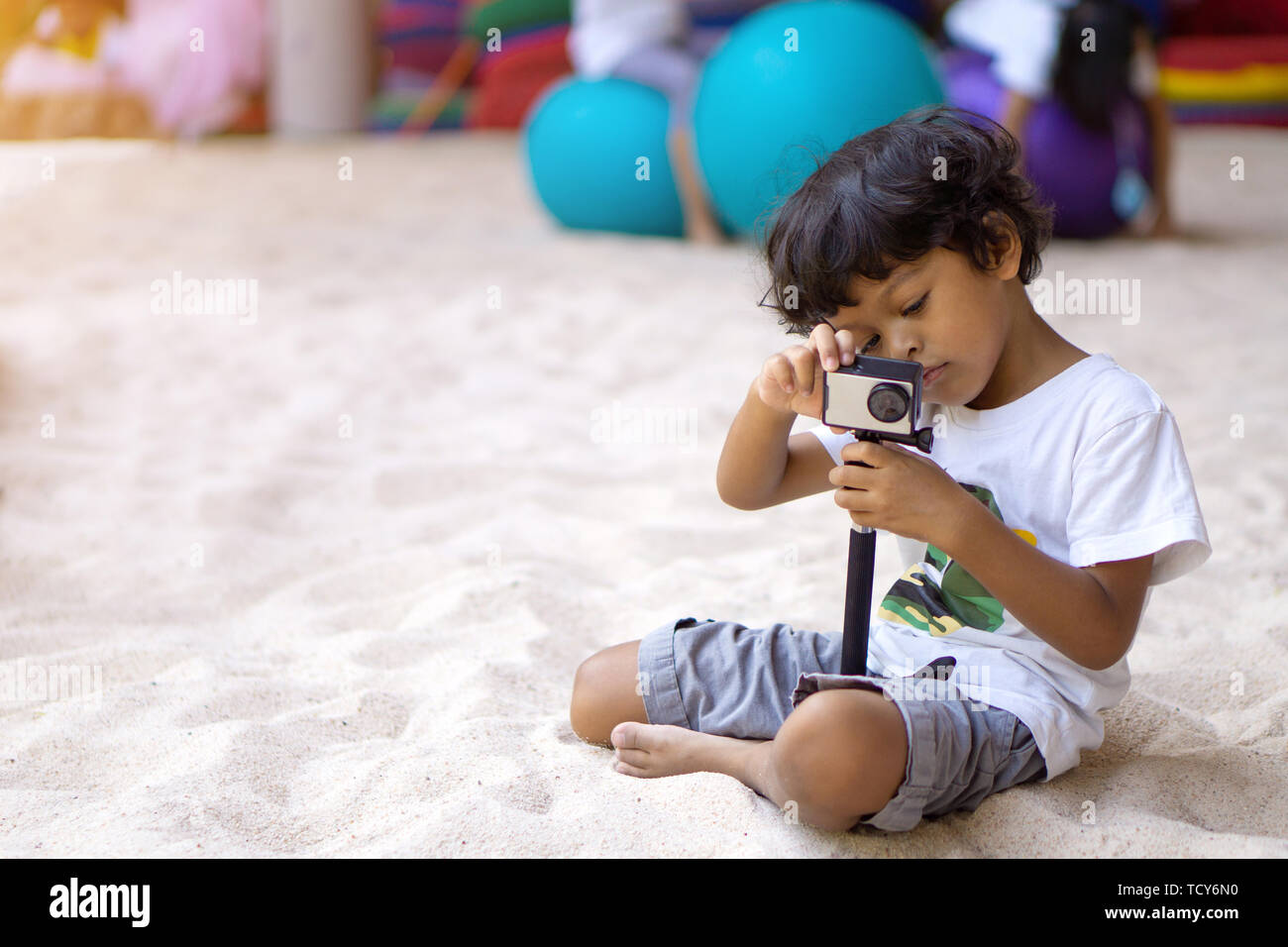 Asian boy using action camera to take a picture or video Stock Photo ...