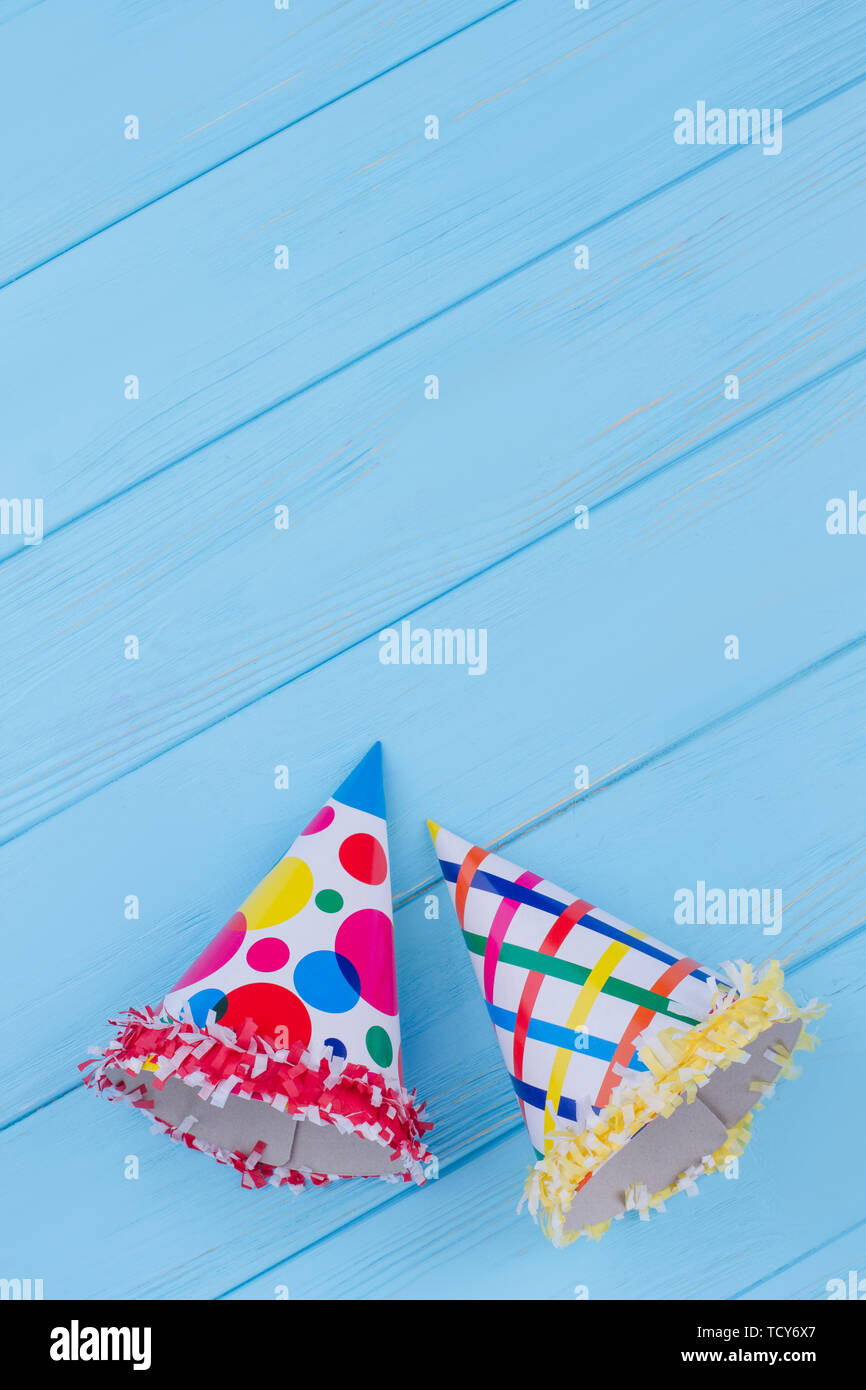 Fun paper party hats on color background Stock Photo - Alamy