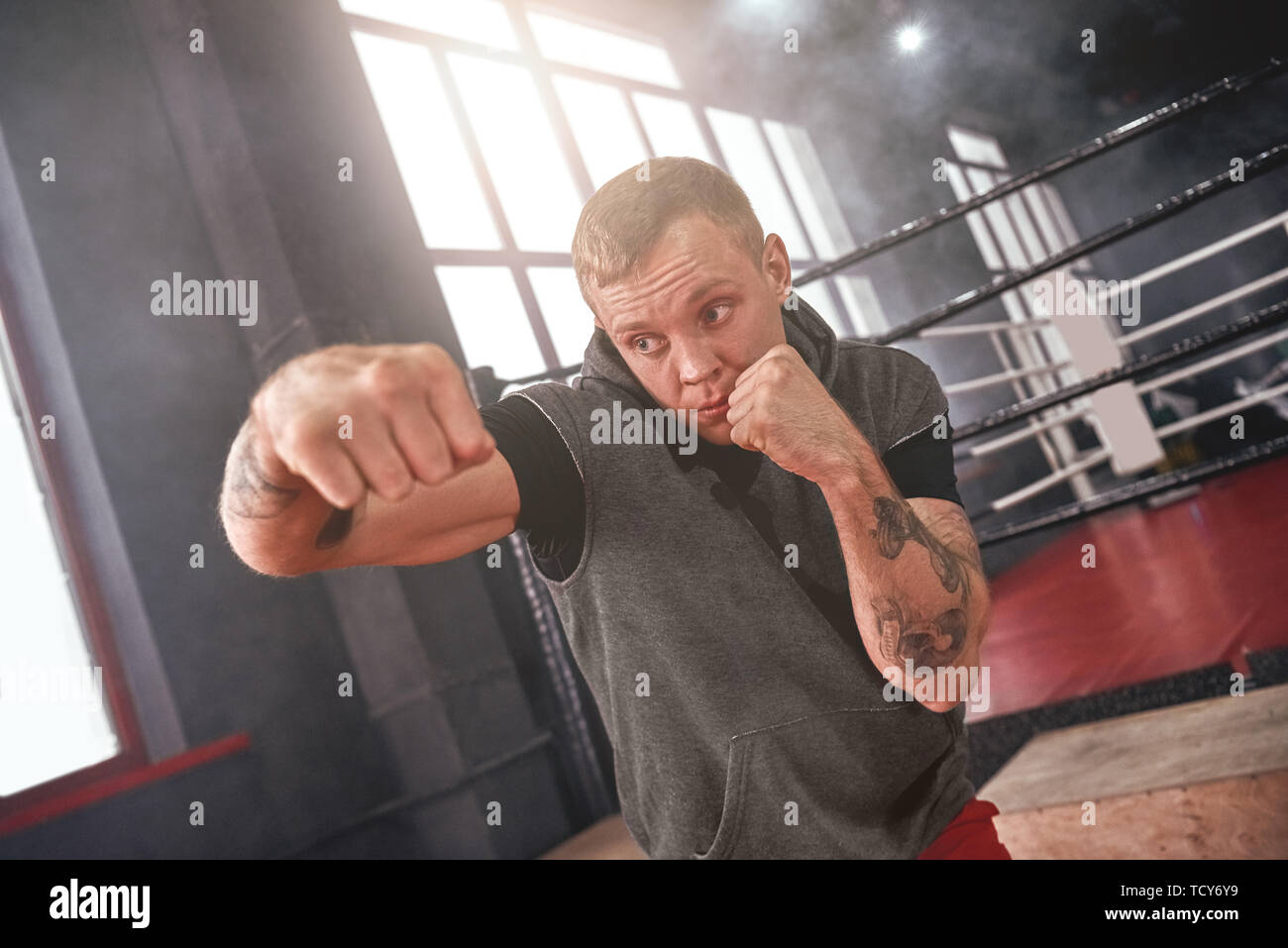 Close-up of confident handsome athlete in sports clothing performing ...
