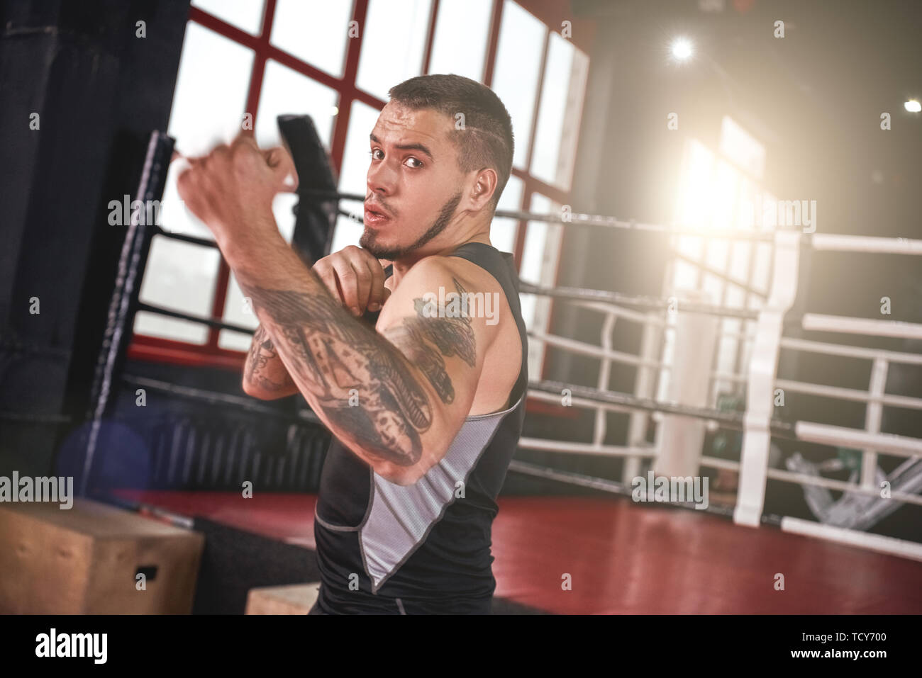 Close-up of young muscular man athlete in sports clothing throwing ...