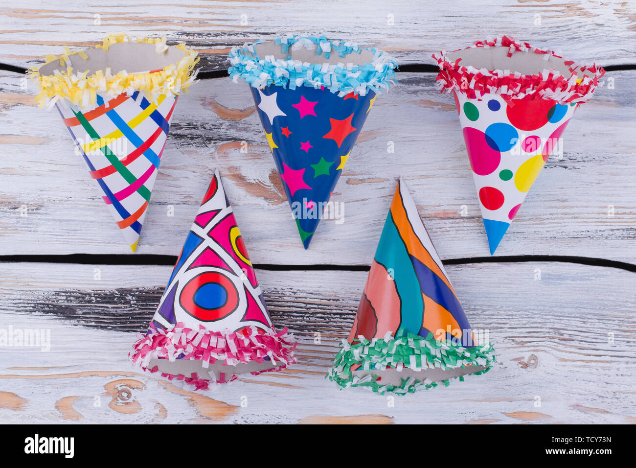 Funny party hats on wooden background Stock Photo - Alamy