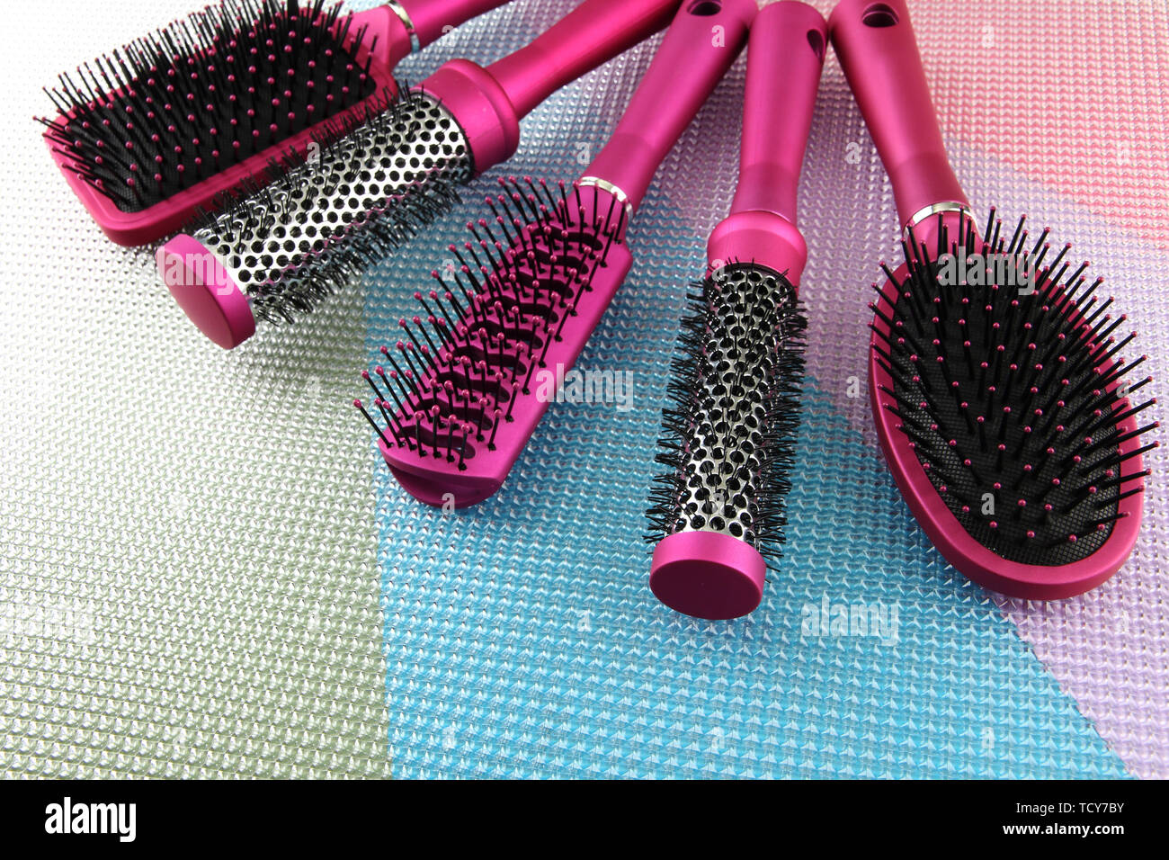 Comb brushes on bright background Stock Photo - Alamy