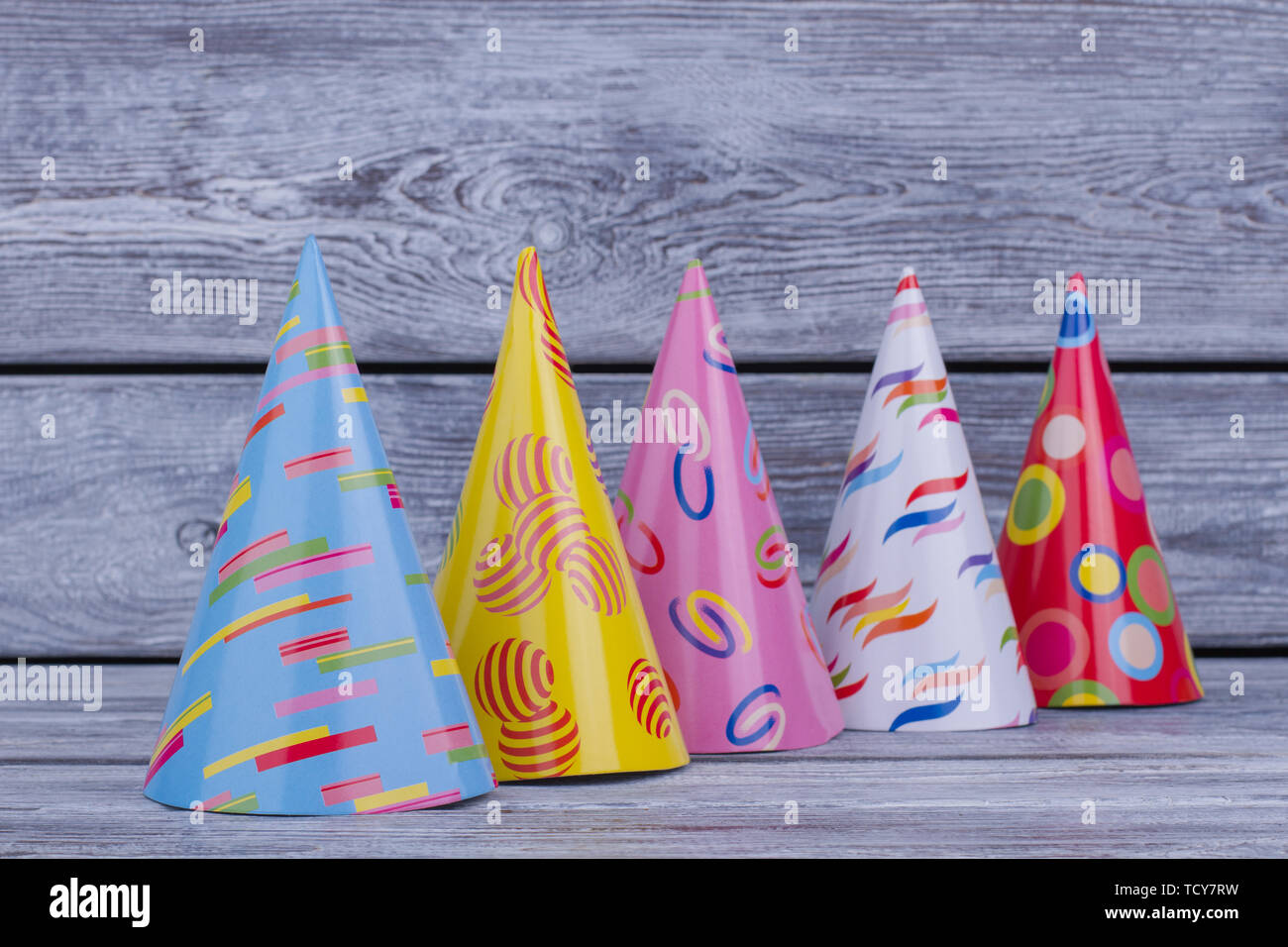 Collection of party hats on wooden background Stock Photo - Alamy