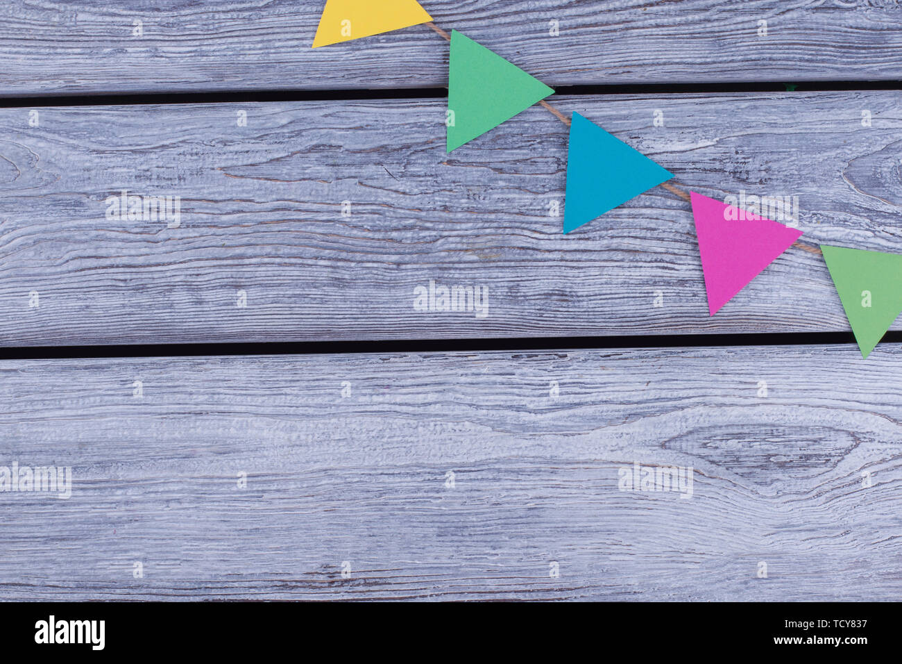 Triangle papers hanging on rope Stock Photo - Alamy