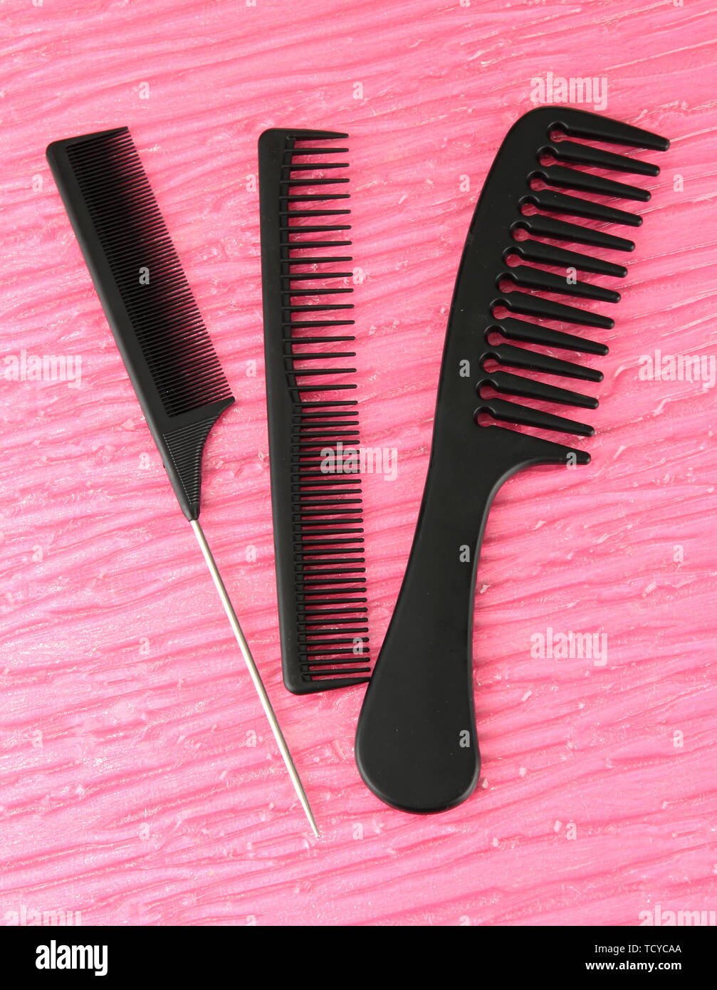 Black combs on color background Stock Photo - Alamy